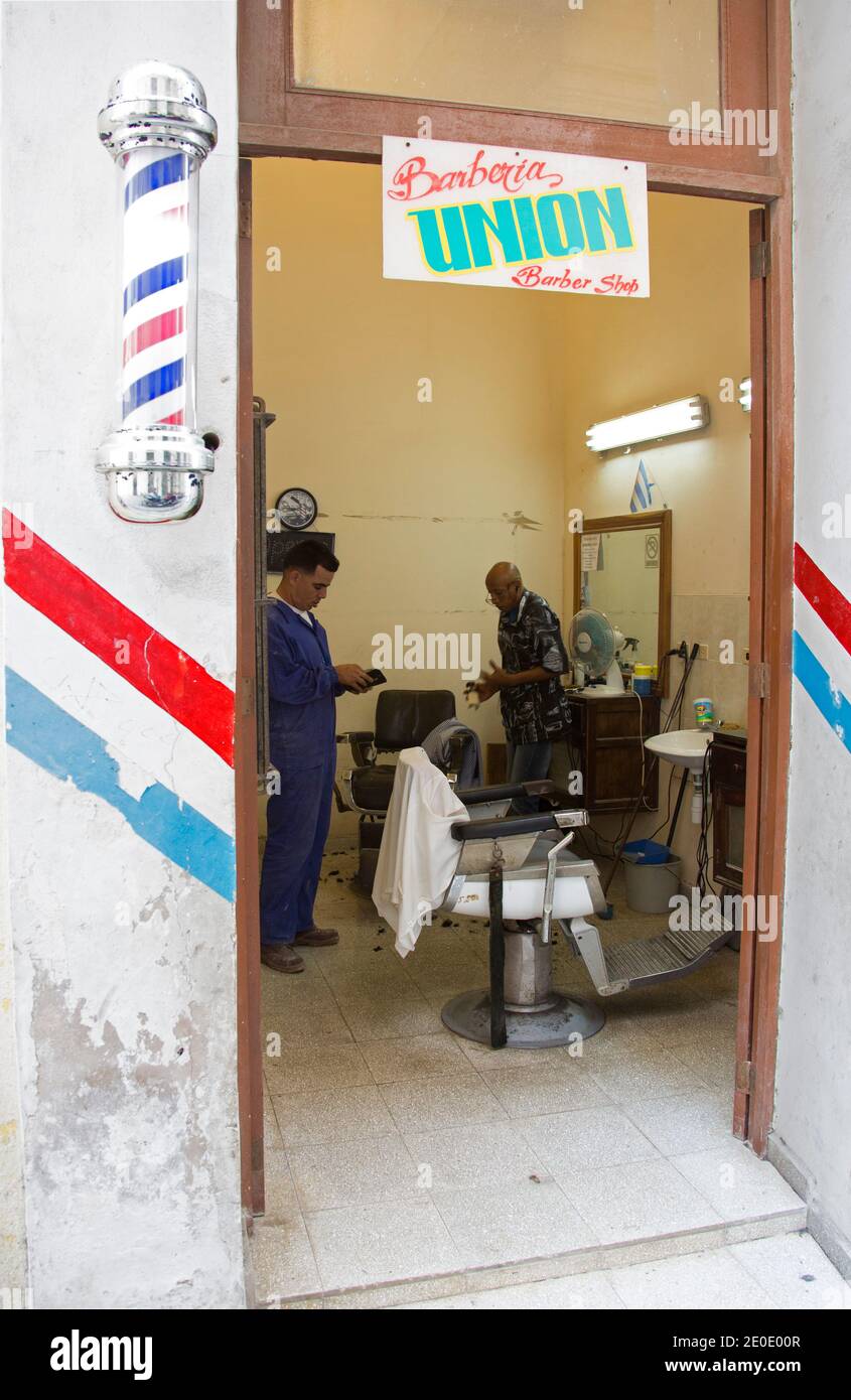 Barber and customer in barbers shop, Havana, Cuba Stock Photo - Alamy