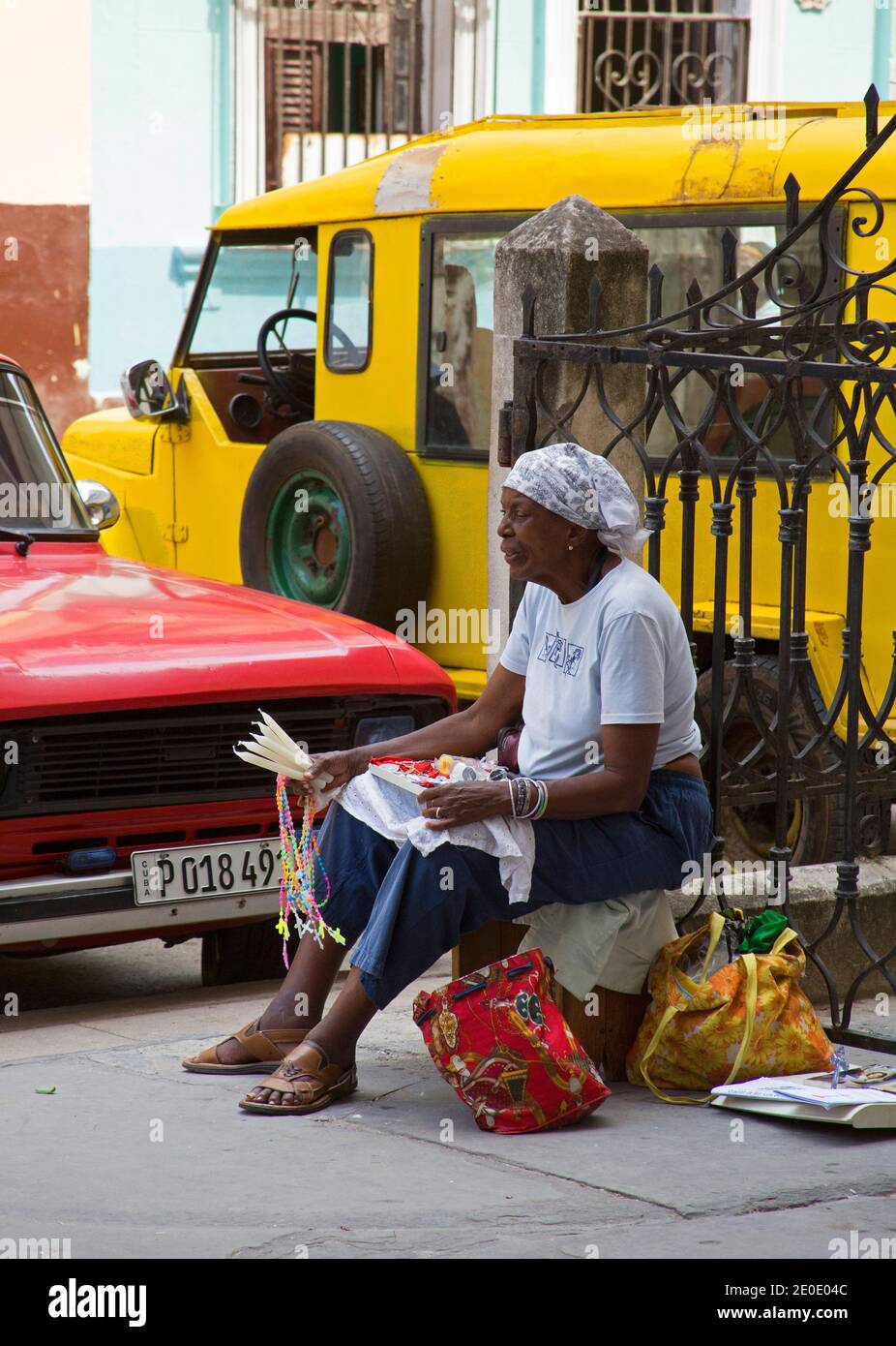Cuban lady selling candles and trinkets on street corner, Old Havana ...
