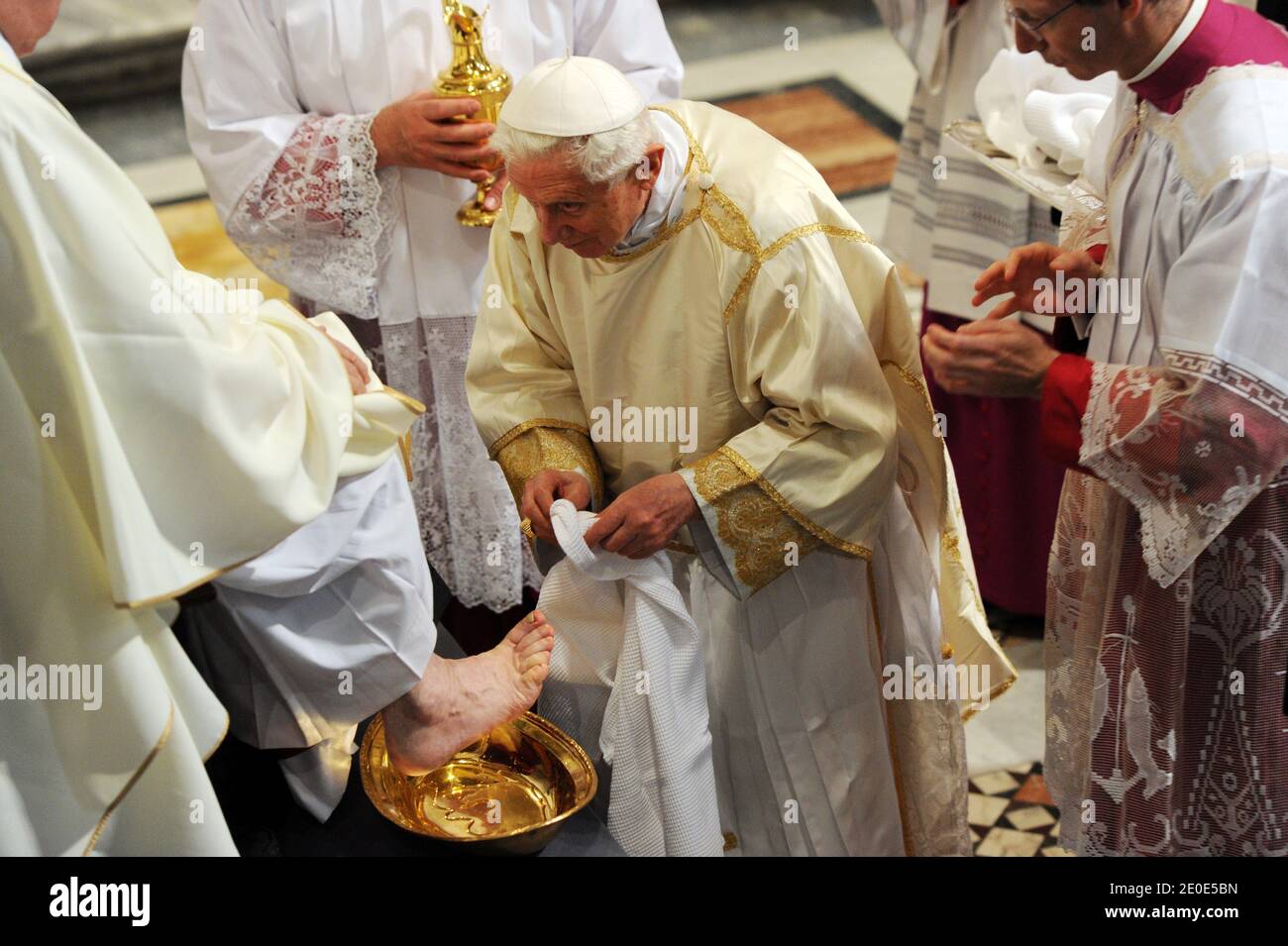 Pope Benedict XVI celebrates the foot washing service during the mass ...