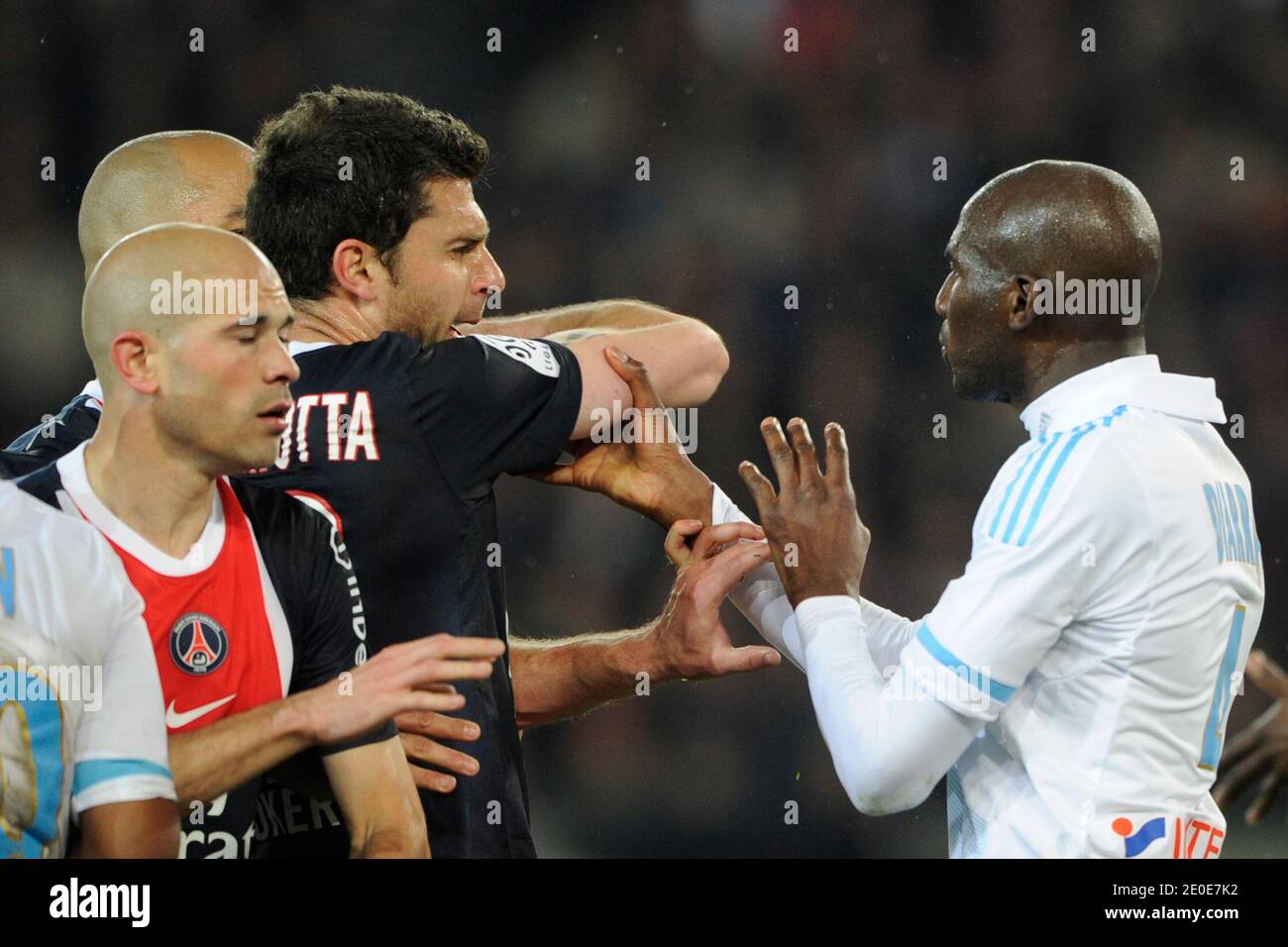 PSG's Alex and Thiago Motta battling Marseille's Alou Diarra during the ...