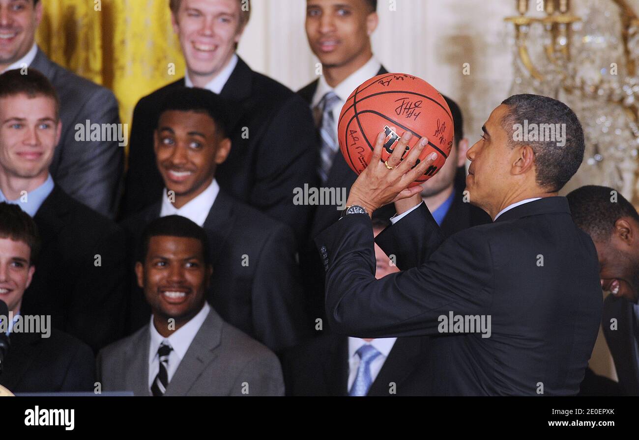 US President Barack Obama plays with a basketball during a celebration ...