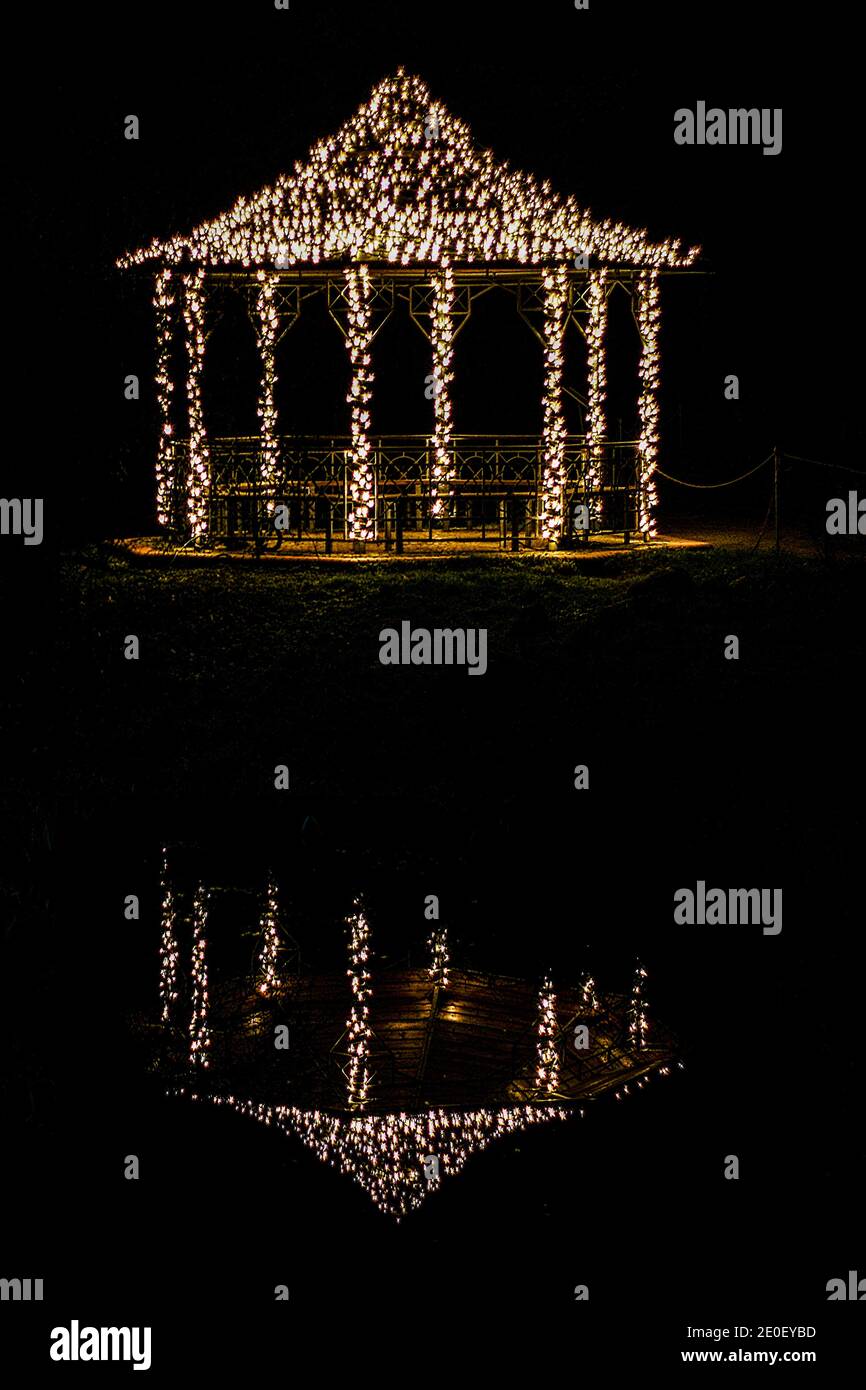 Reflections of lights on a lake surface of an Illuminated garden ...