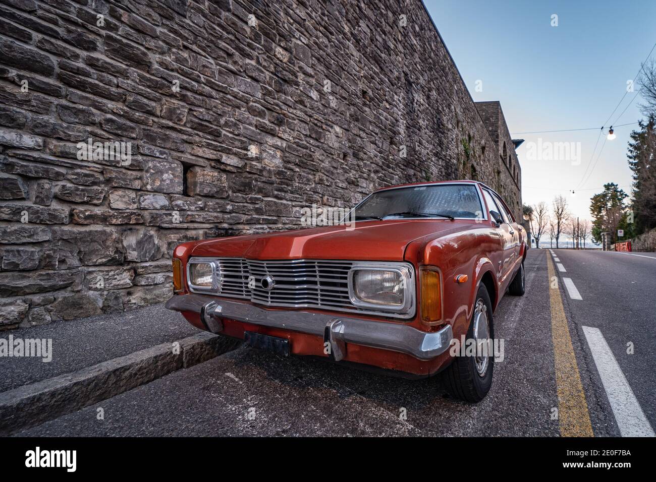 Old red muscle car parked on the edge of a road in Italy Stock Photo ...