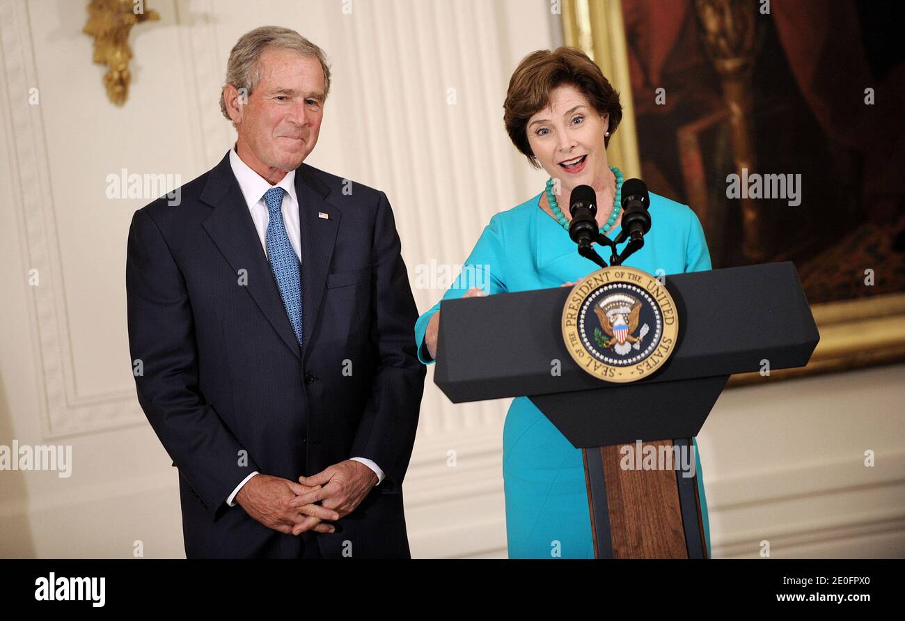 Former President George W. Bush looks on as Former First Lady Laura ...