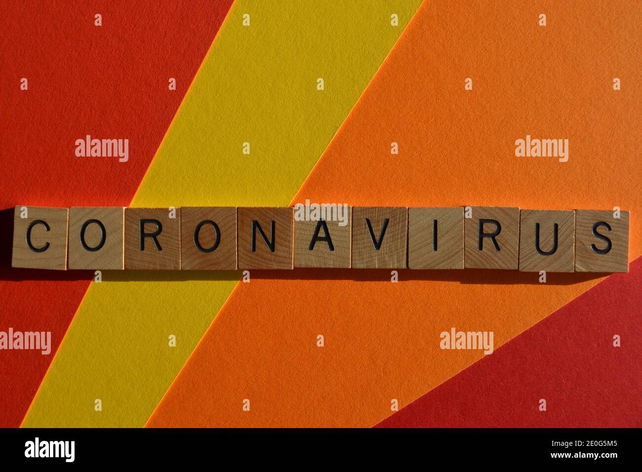 Coronavirus, word in wooden alphabets letters isolated on vibrant ...