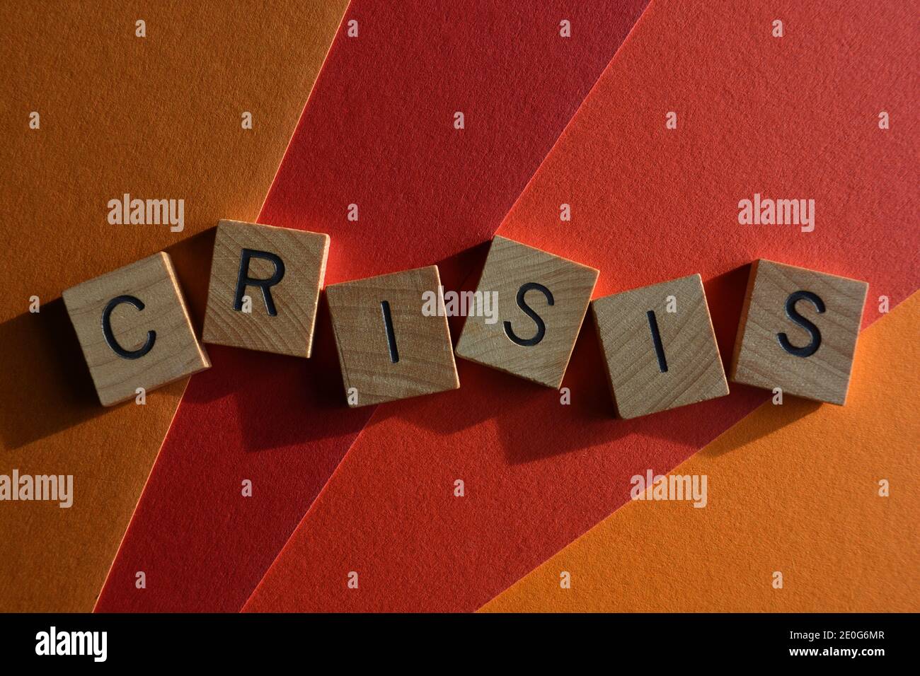 Crisis, word in wooden alphabet letters isolated on red and orange ...
