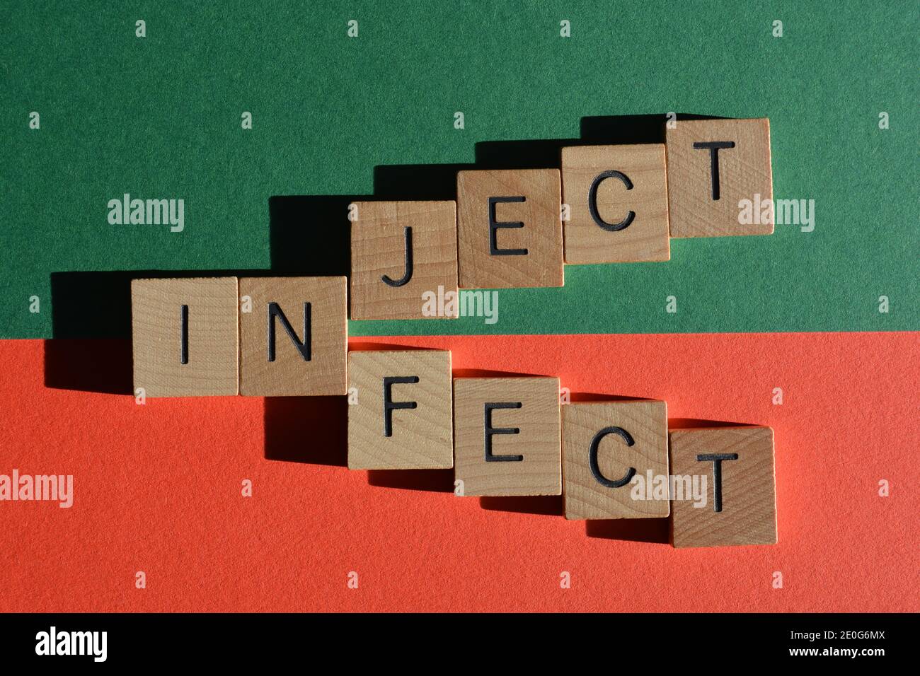 Inject, Infect, words in wooden alphabet letters isolated on green and ...