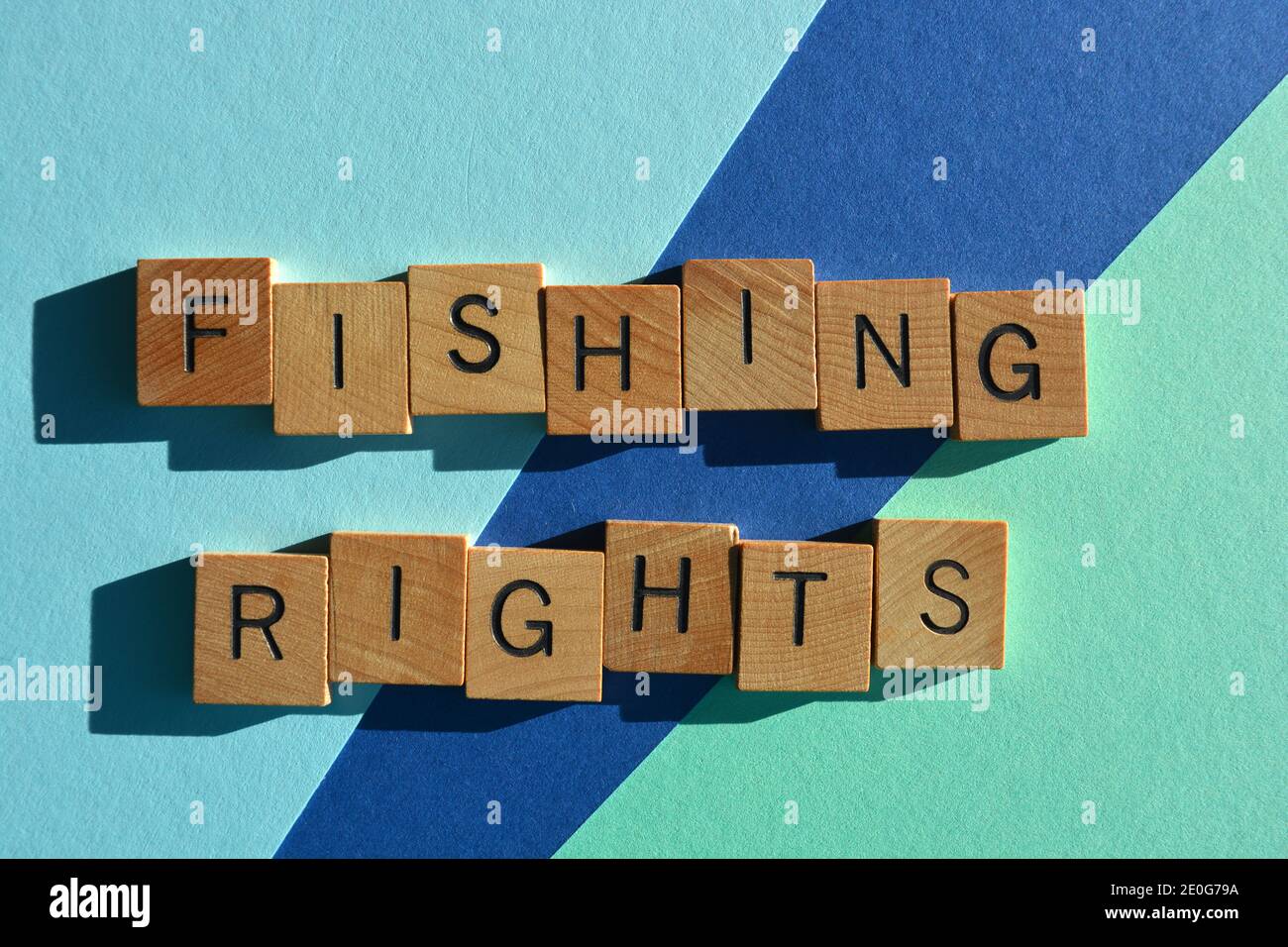 Fishing Rights, words in wooden alphabet letters isolated on blue ...
