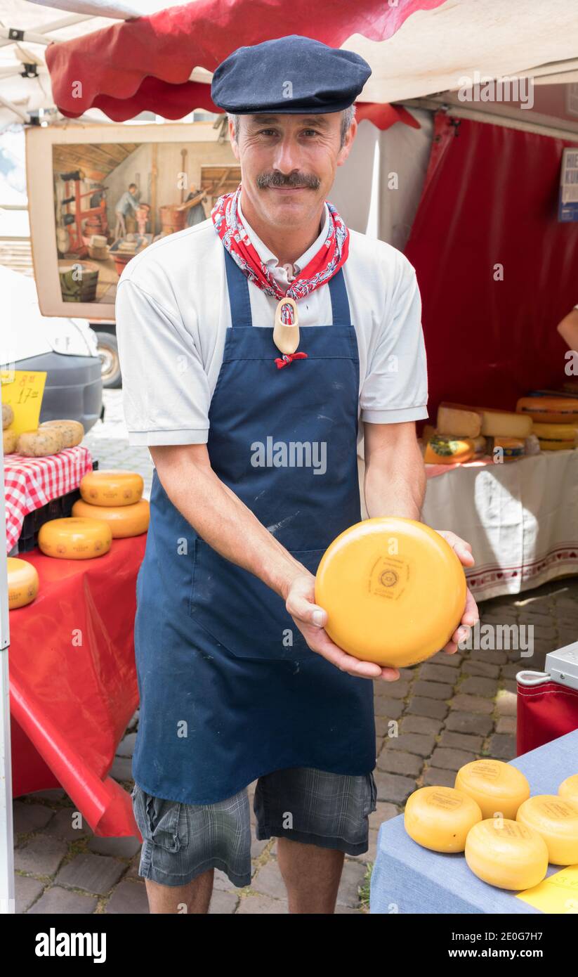 Cheese Vendor Holding a Wheel Of Gouda Cheese at the Gouda Cheese ...