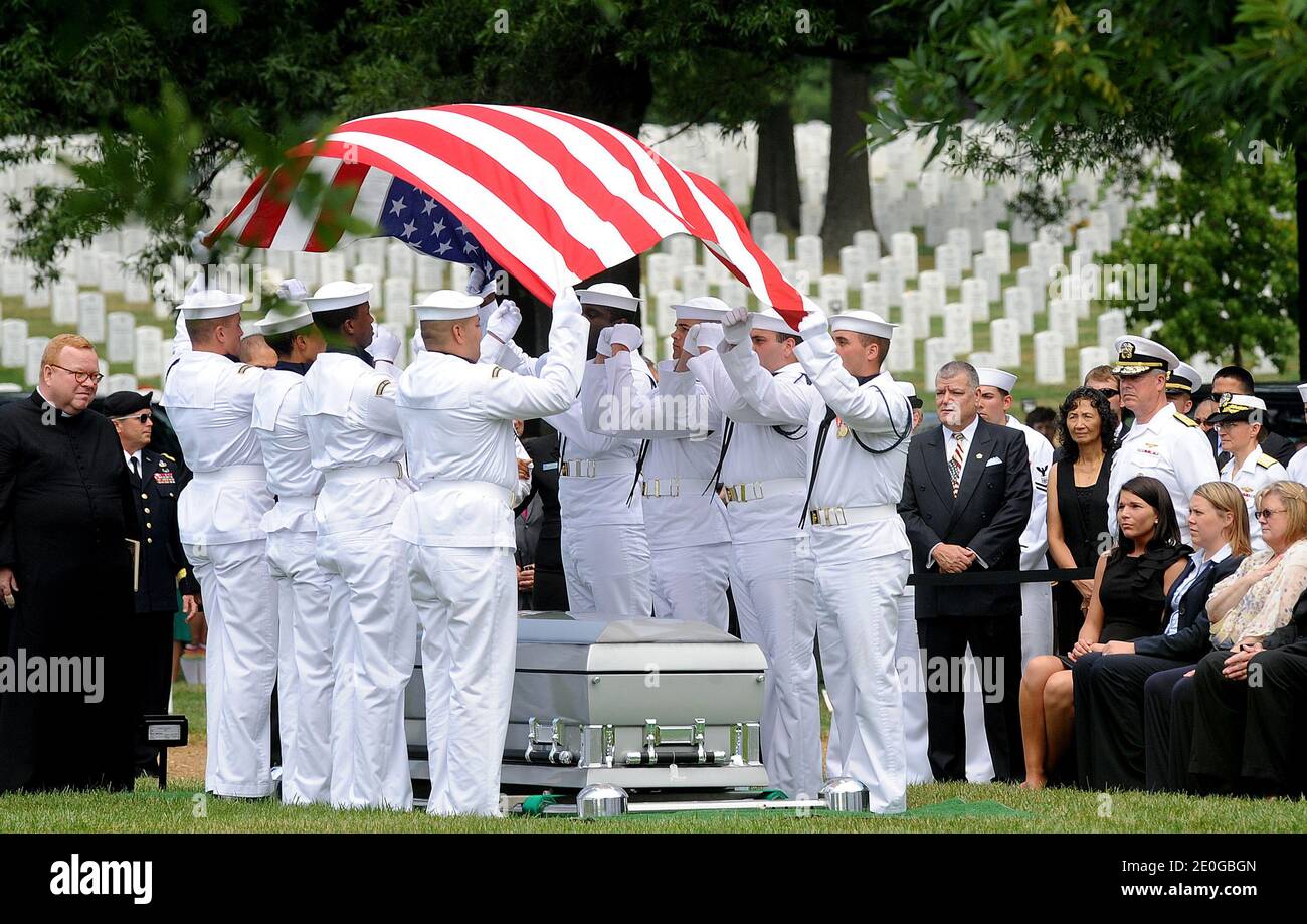 Honor guard team folds the American flag of the casket of U.S. Navy ...