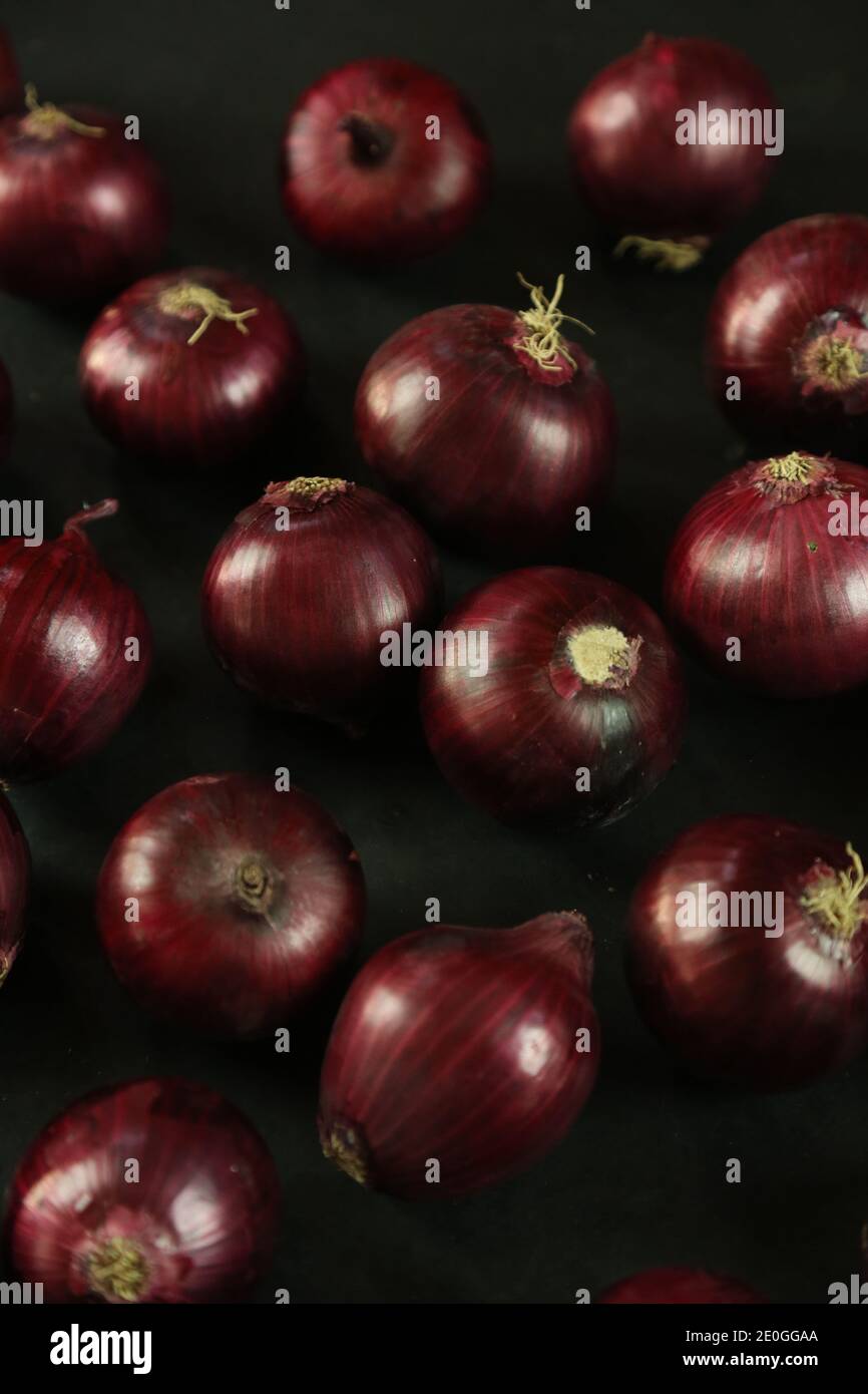 sweet red onions on background Stock Photo - Alamy