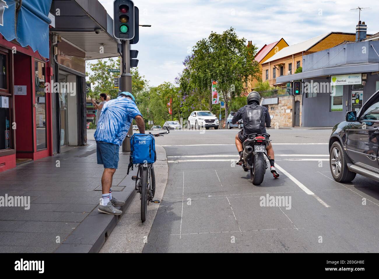 A middle aged man wearing a helmet prepares to ride his bicycle on a ...