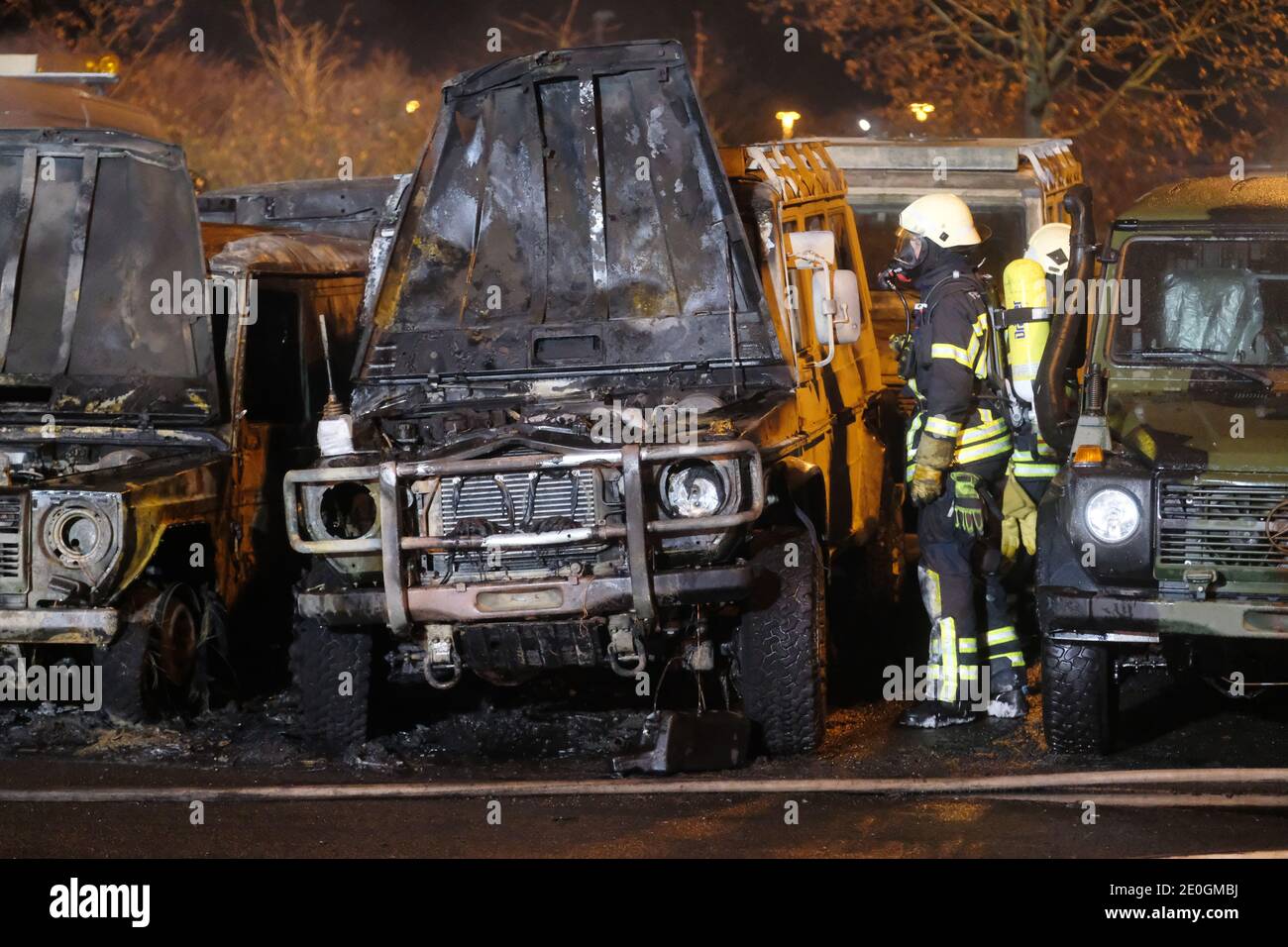 Leipzig, Germany. 31st Dec, 2020. A firefighter stands by burned-down ...