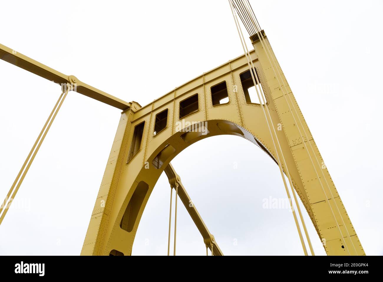 Yellow upright of a self anchored suspension bridge seen from below ...