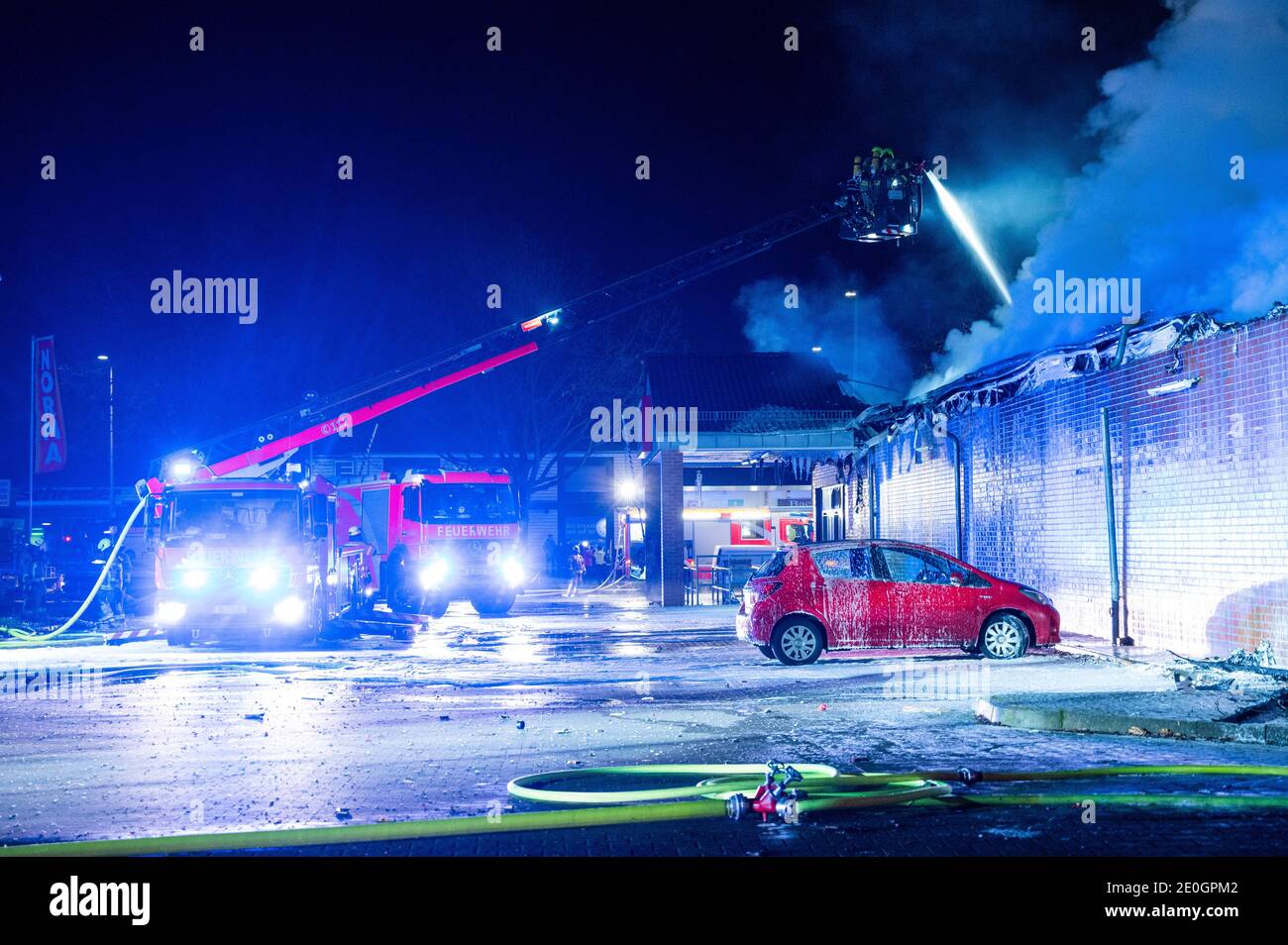 Berlin, Germany. 01st Jan, 2021. Firefighters extinguish a burning ...