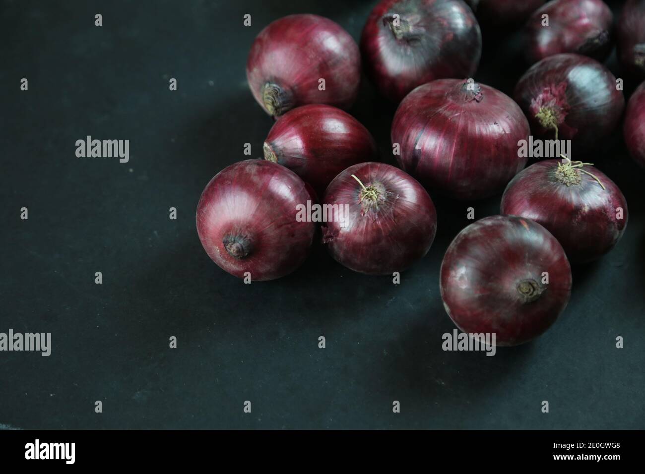 sweet red onions on background Stock Photo - Alamy