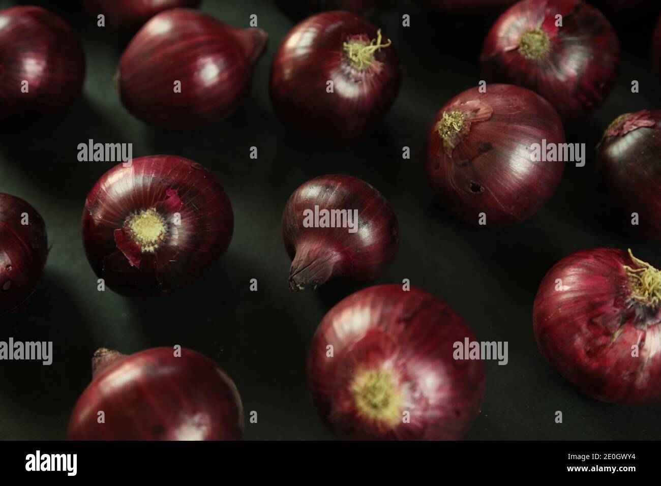 sweet red onions on background Stock Photo - Alamy