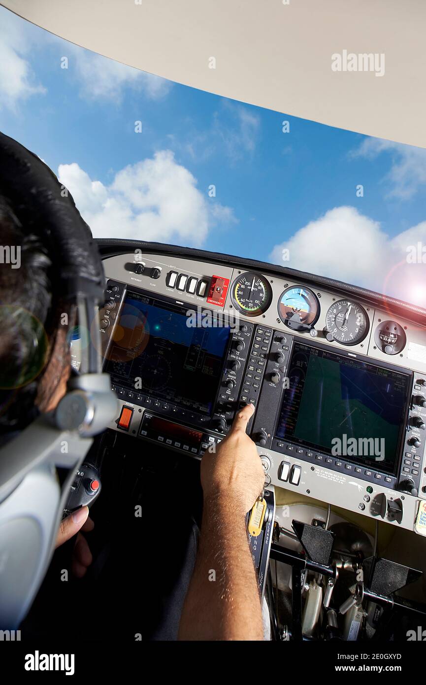 Airplane pilot touching control panel in cockpit Stock Photo - Alamy