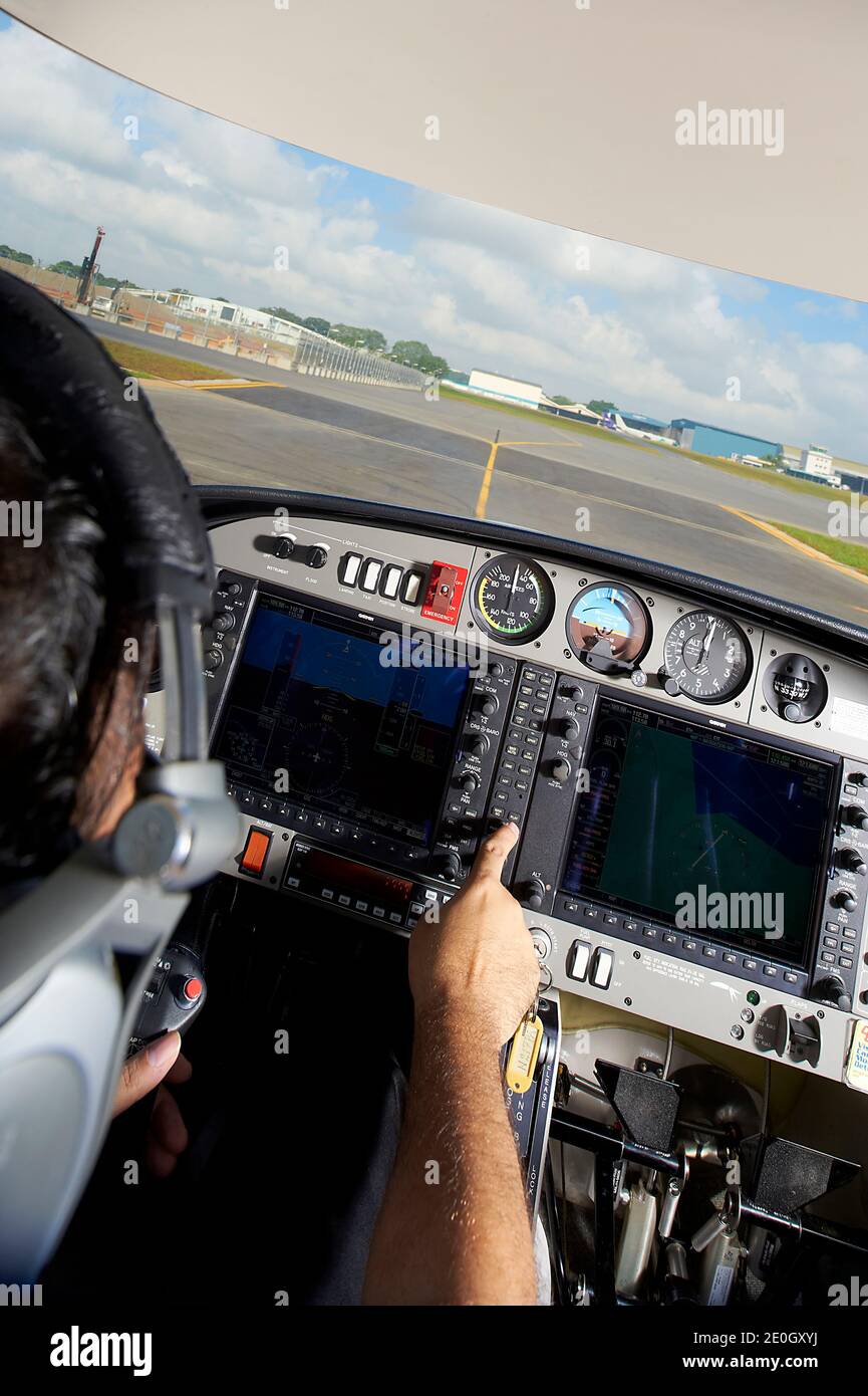 Airplane pilot touching control panel in cockpit Stock Photo - Alamy