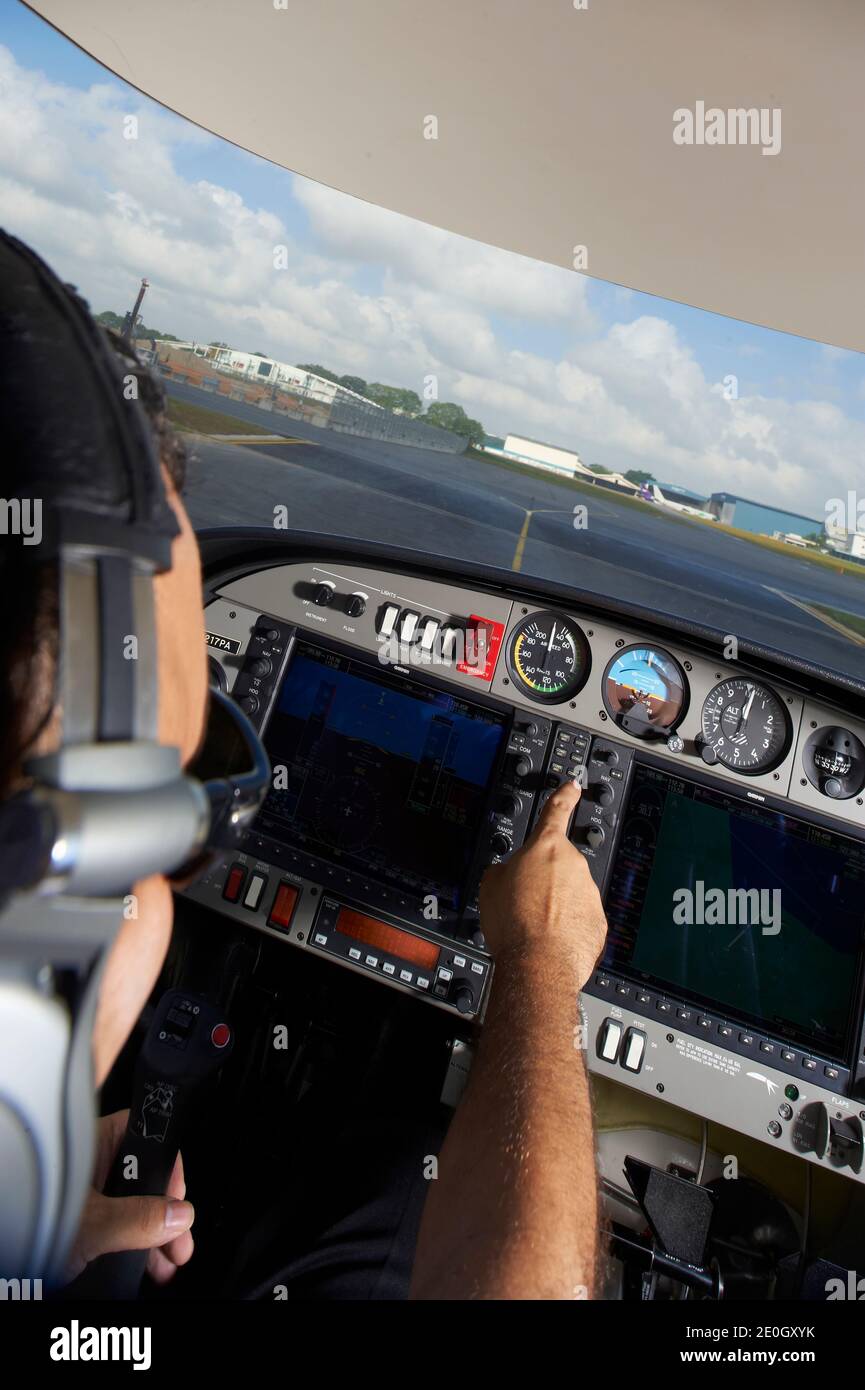 Airplane pilot touching control panel in cockpit Stock Photo - Alamy
