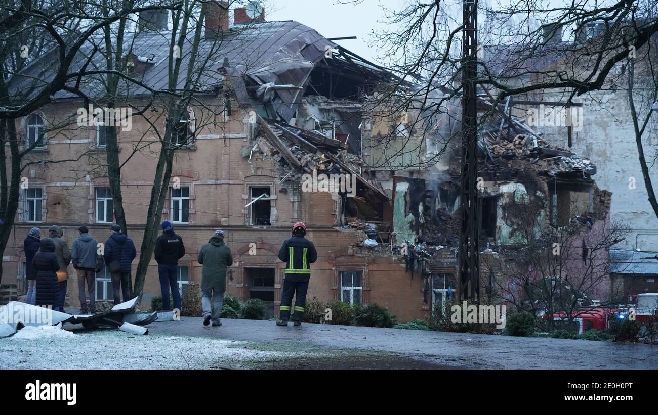 Riga, Latvia. 31st Dec, 2020. People stand beside a collapsed three ...