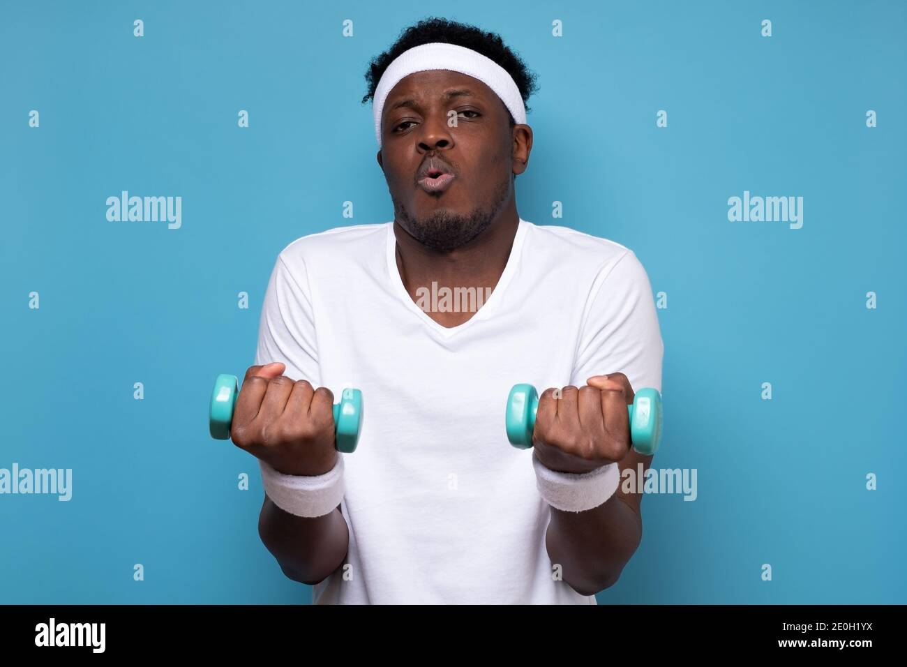 Strong young african fitness sports man doing exercise with dumbbells ...