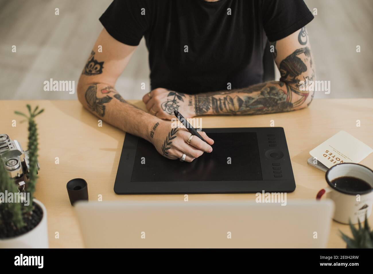 tattood man using creative technology Stock Photo - Alamy