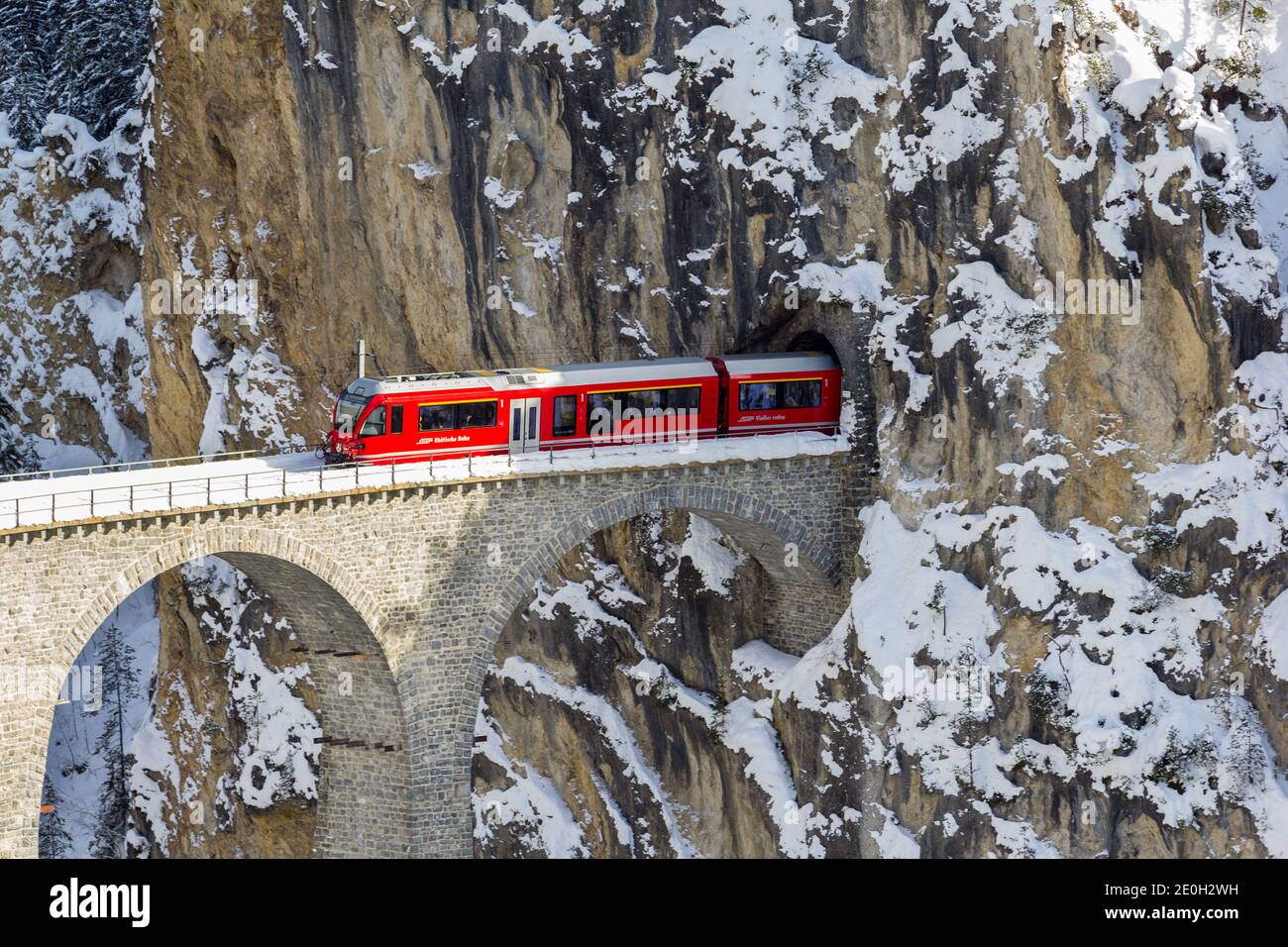 Filisur, Switzerland - January 19. 2019: A red passenger Swiss train is ...