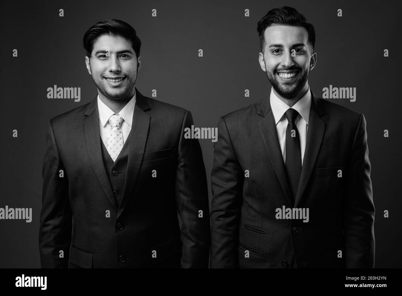 Studio shot of young handsome Iranian brothers together shot in black ...