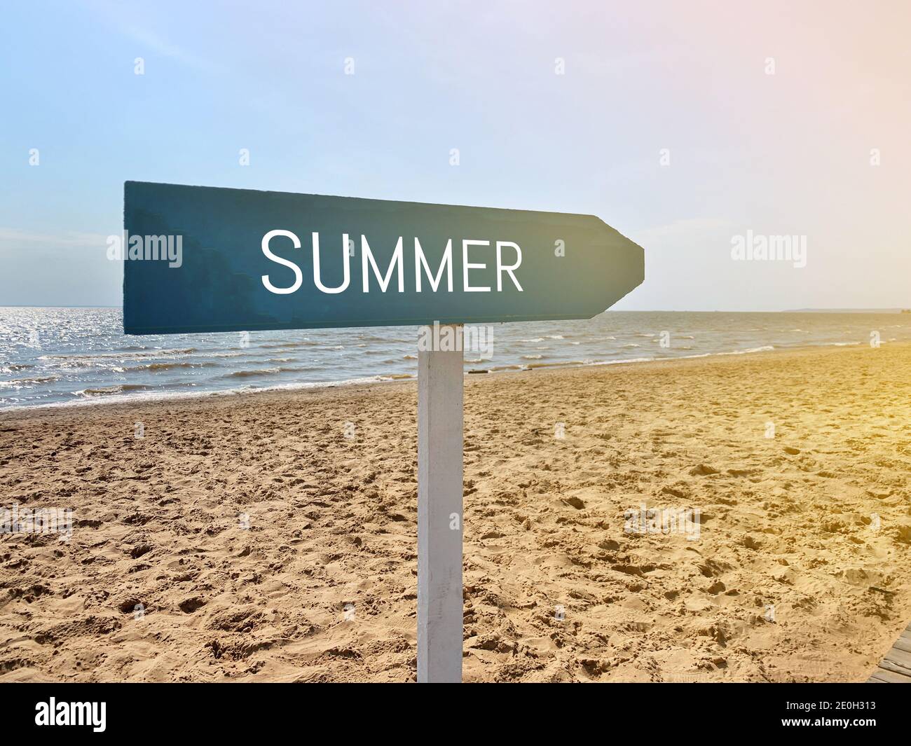 Wooden pointer on the beach. Vertical Stock Photo - Alamy