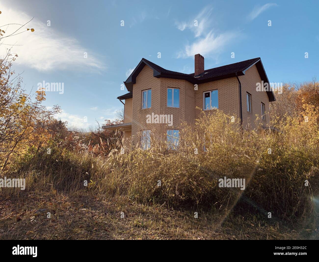 Modern mansion in light colors in autumn Stock Photo - Alamy