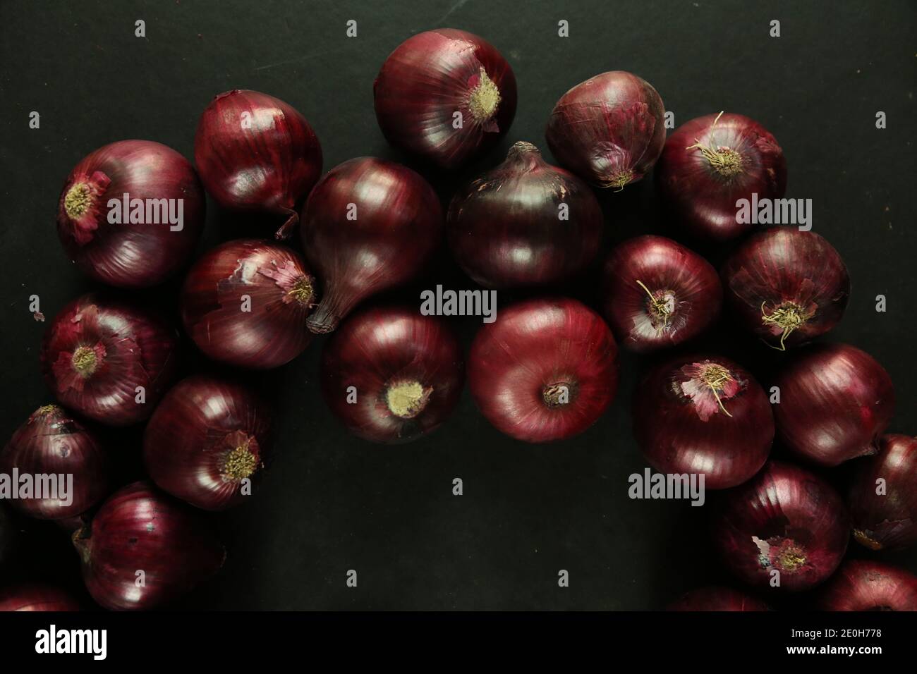sweet red onions on background Stock Photo - Alamy