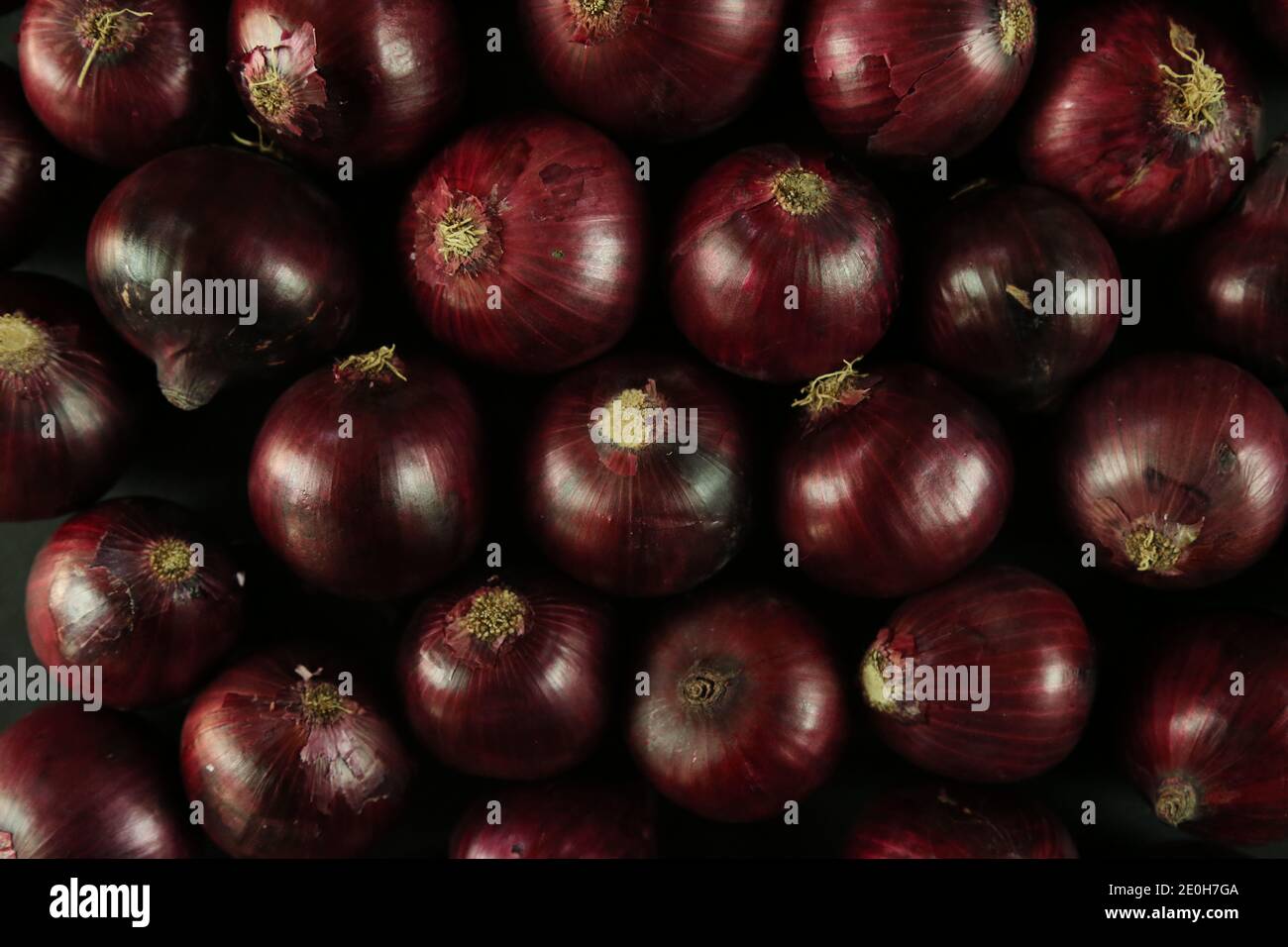 sweet red onions on background Stock Photo - Alamy