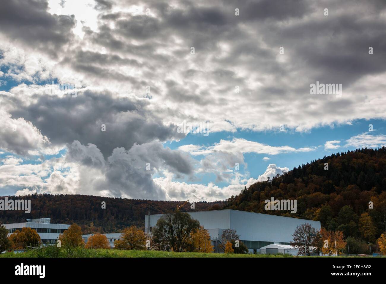 Factory in the middle of the colorful countryside Stock Photo - Alamy