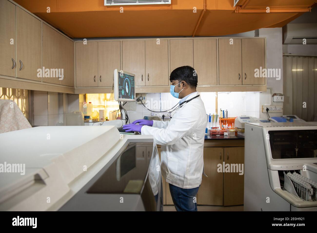 male doctor using advance scanning machine computer at hospital ...