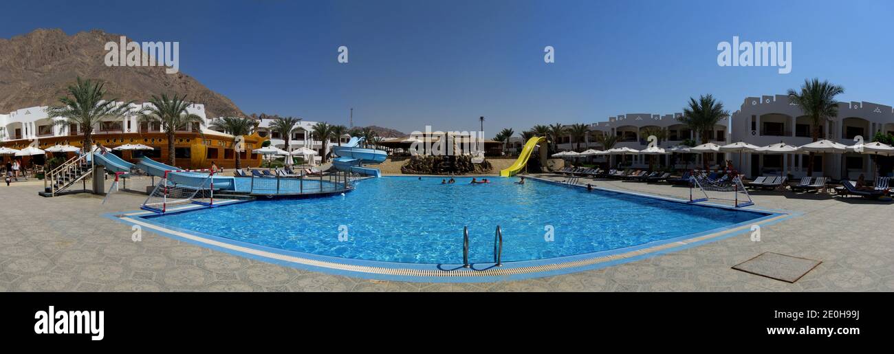 big blue pool with palms in the holiday panorama Stock Photo - Alamy