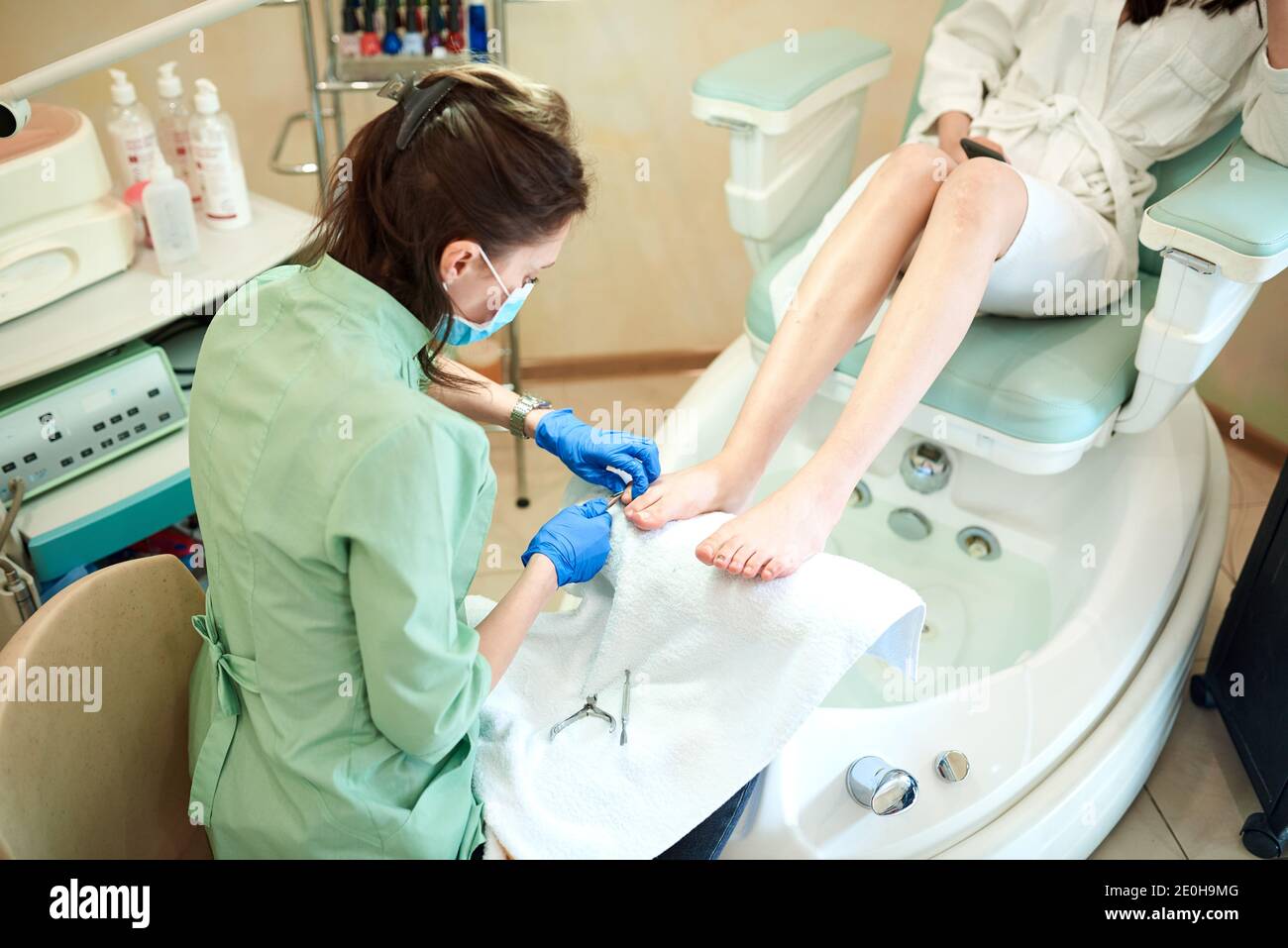 Woman feet receiving pedicure. Beautician doing pedicure. Close up ...