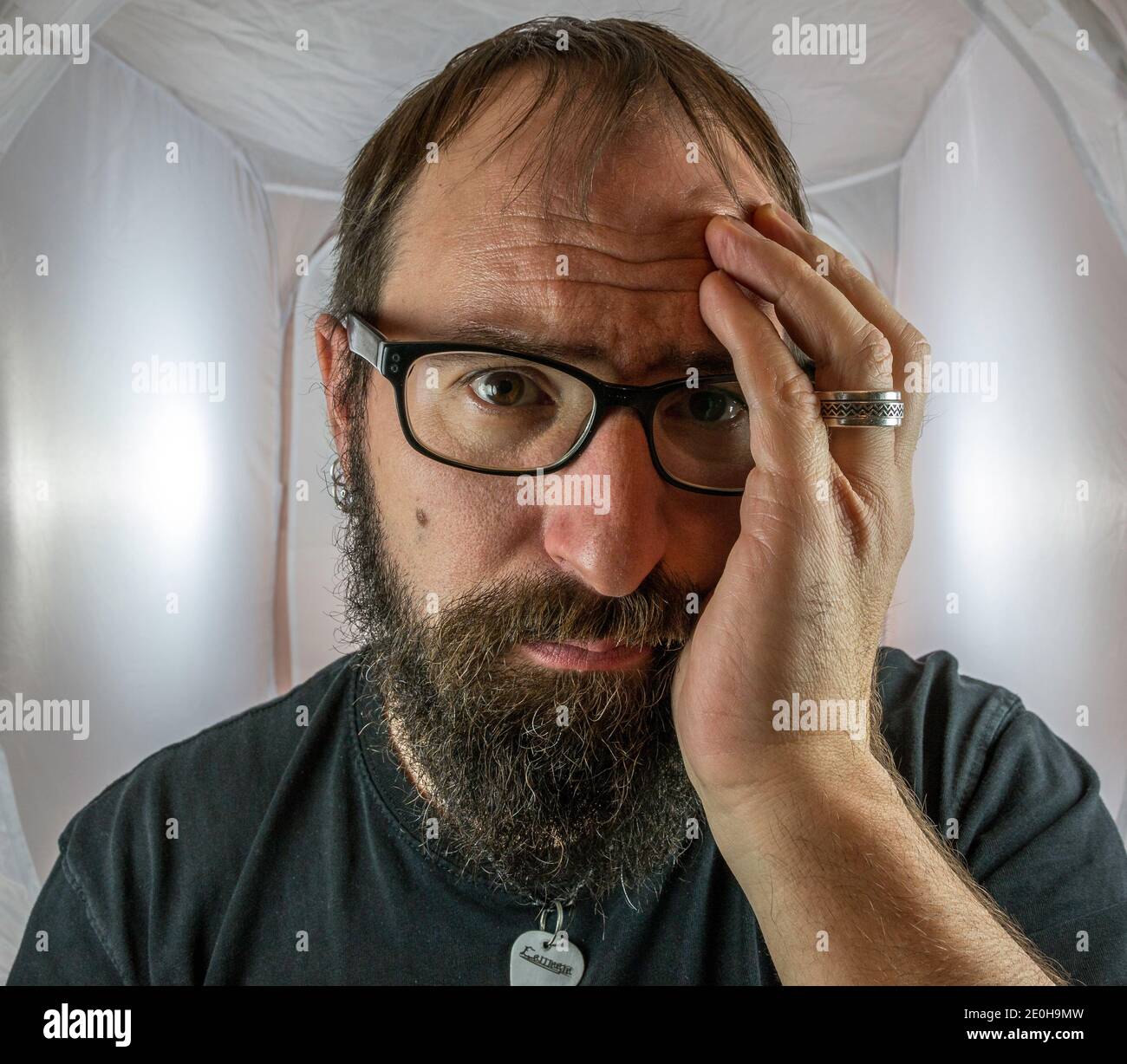 A bearded sad looking man in a depressive mood Stock Photo - Alamy