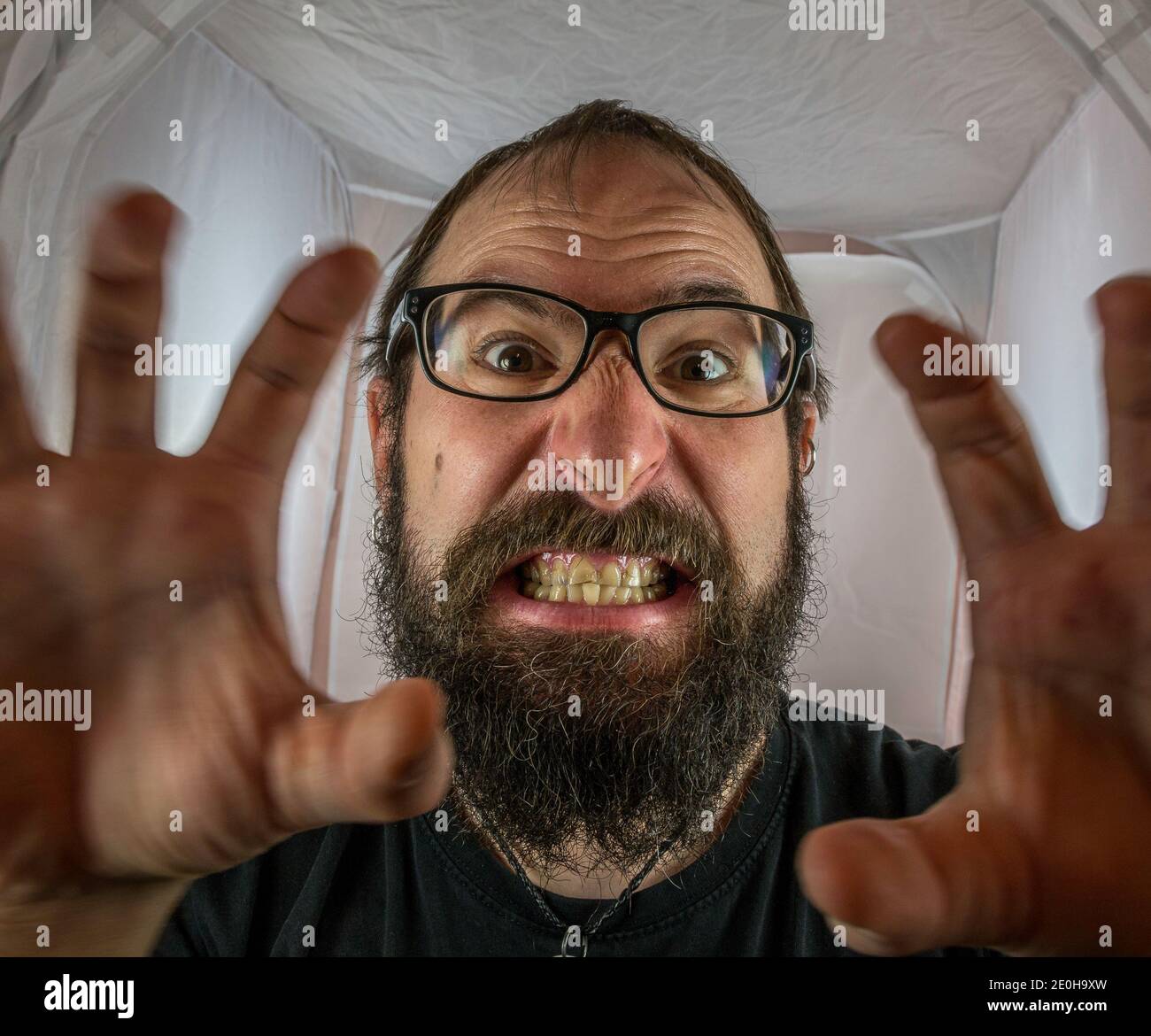 A bearded scary looking man with black glasses Stock Photo - Alamy