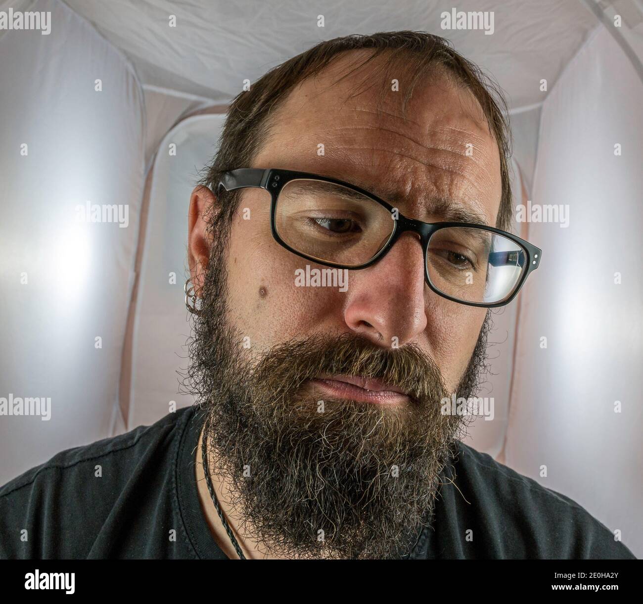 A bearded sad looking man in a depressive mood Stock Photo - Alamy