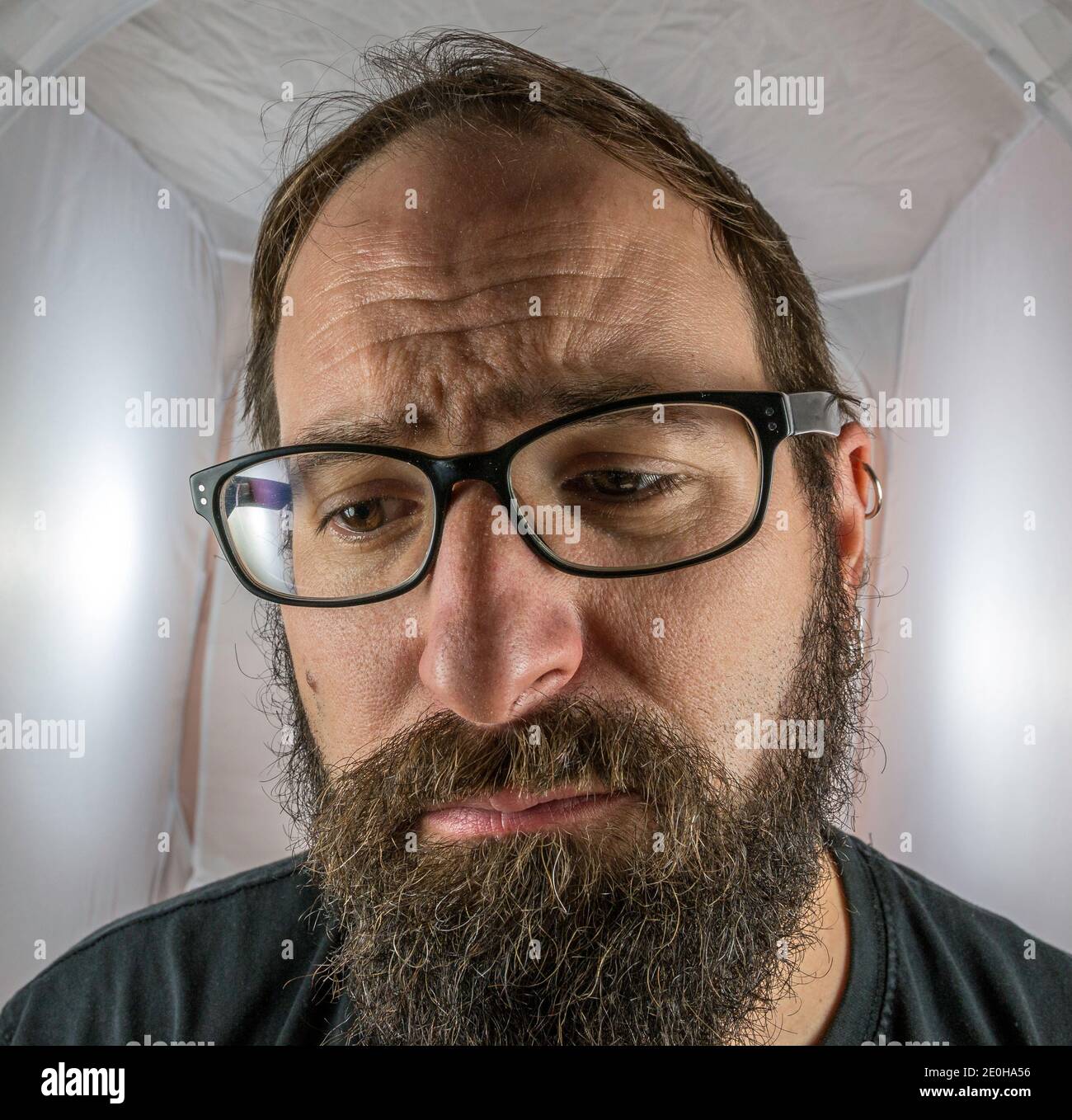A bearded sad looking man in a depressive mood Stock Photo - Alamy