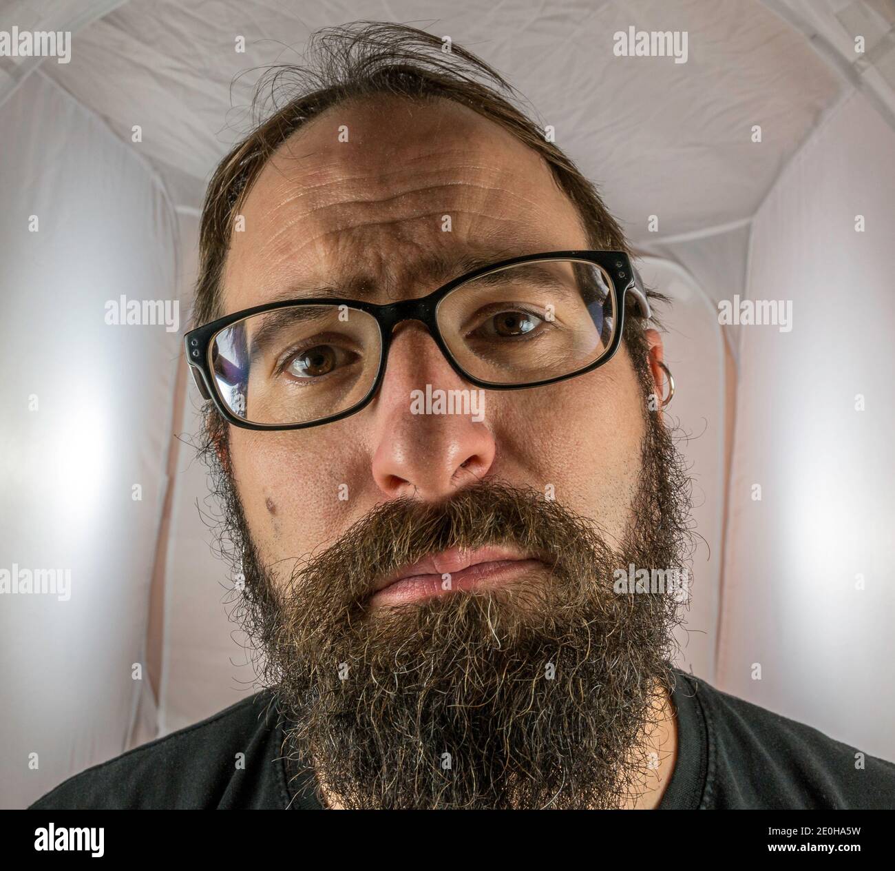 A bearded sad looking man in a depressive mood Stock Photo - Alamy