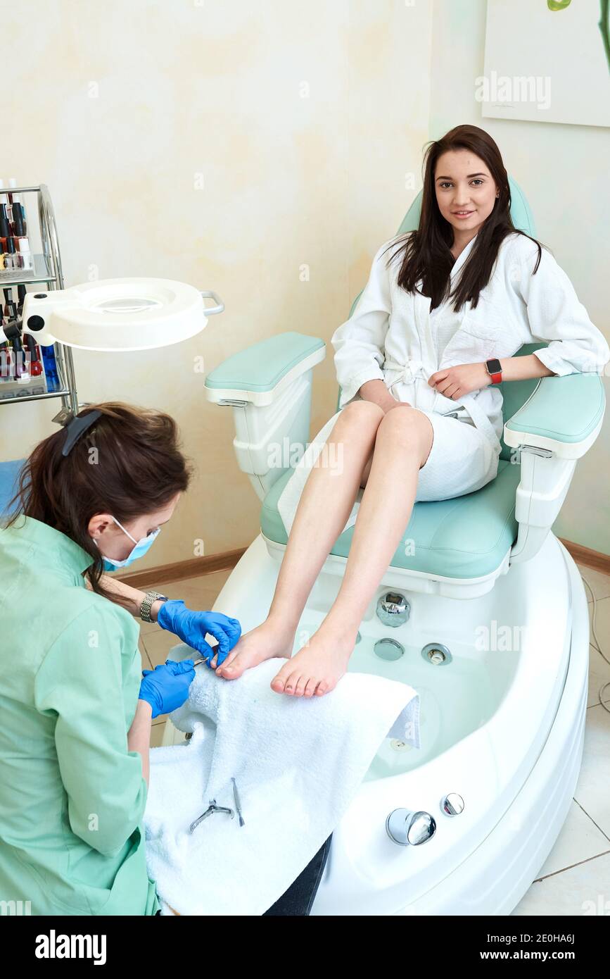 Woman feet receiving pedicure. Beautician doing pedicure. Close up ...
