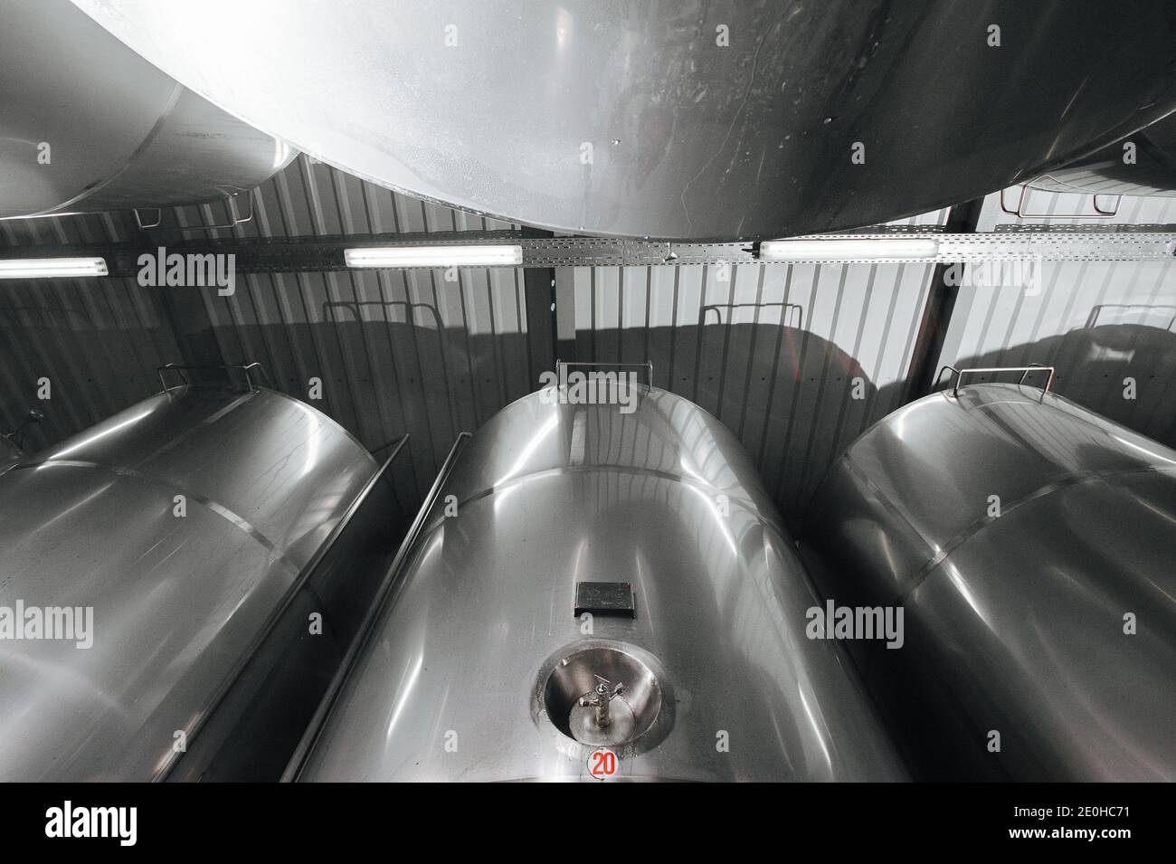 The interior of the brewery. Modern beer factory. Rows of steel ...