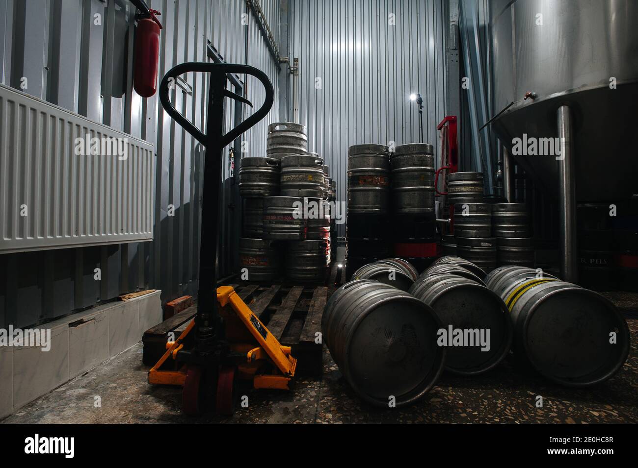 Steel industrial stack of beer kegs against. Modern brewery and ...