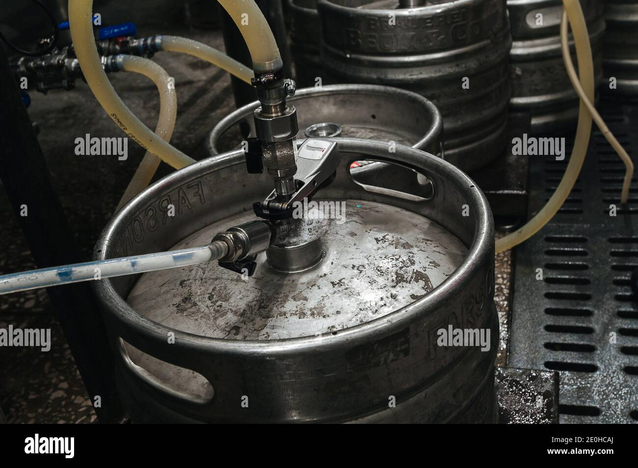 Steel industrial stack of beer kegs against. Modern brewery and ...