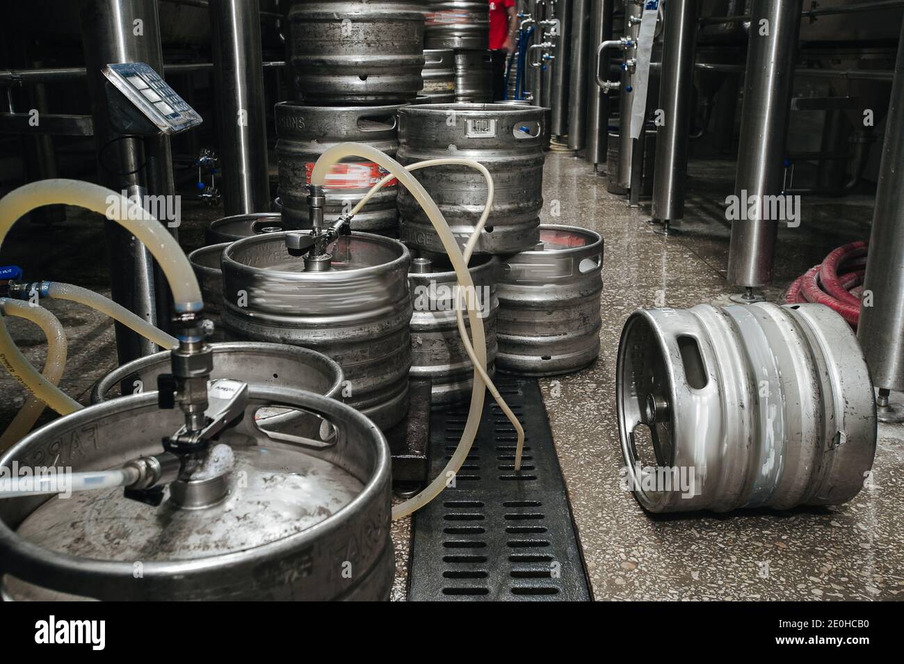 Steel industrial stack of beer kegs against. Modern brewery and ...