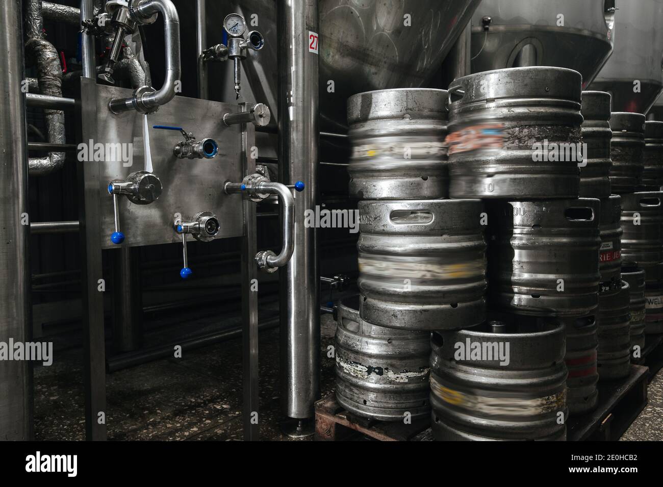 Steel industrial stack of beer kegs against. Modern brewery and ...
