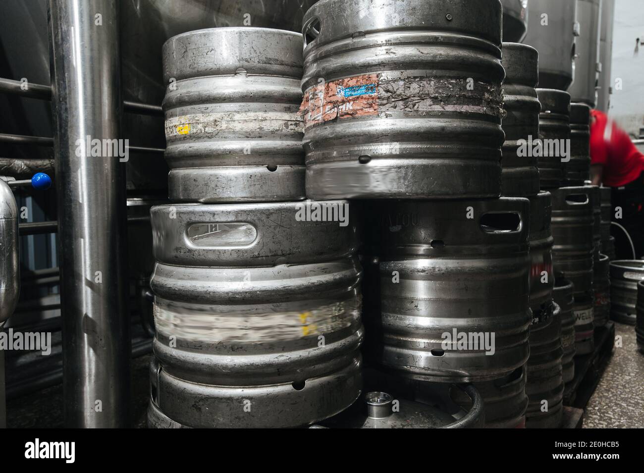 Steel industrial stack of beer kegs against. Modern brewery and ...