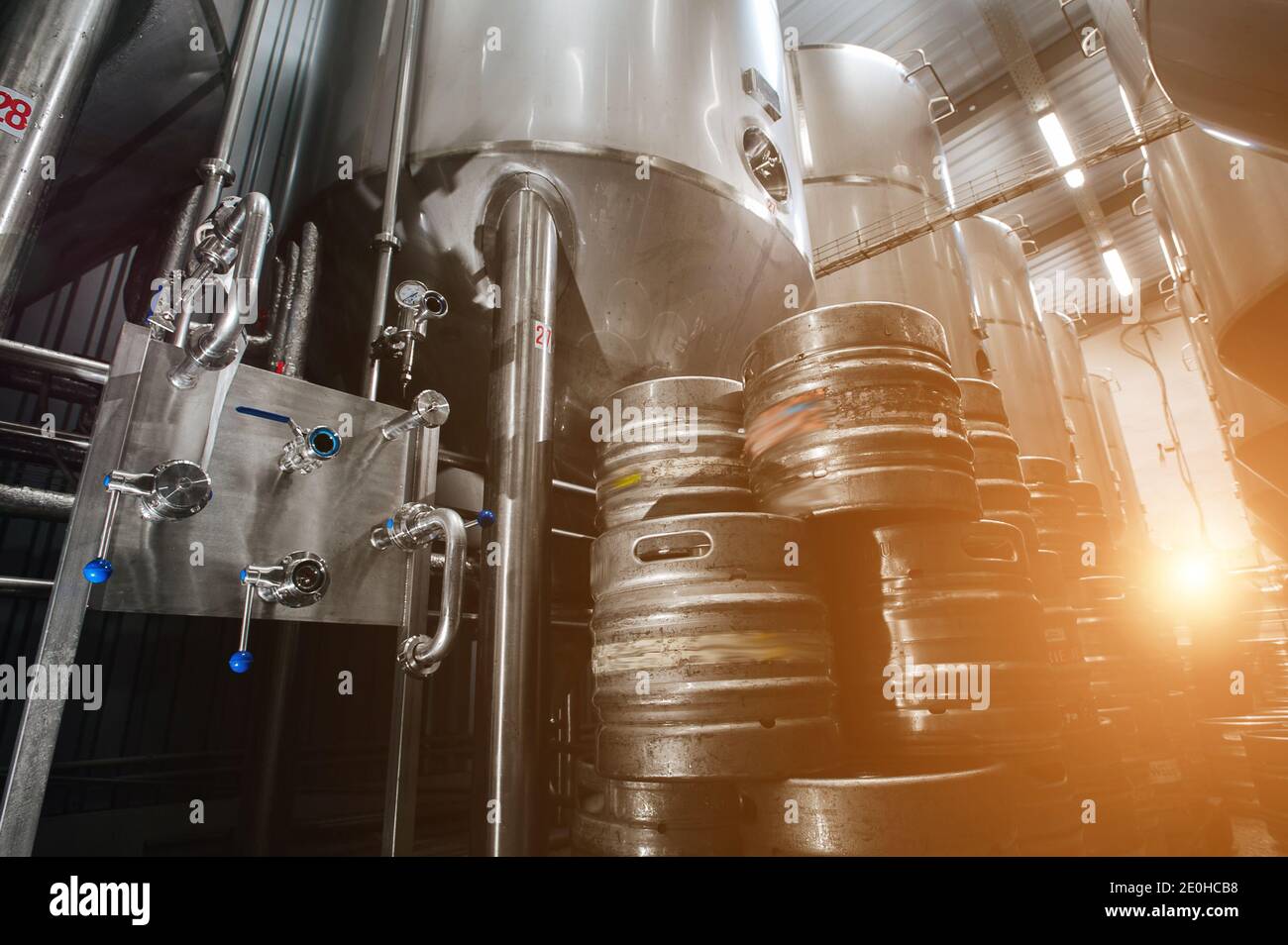 Steel industrial stack of beer kegs against. Modern brewery and ...